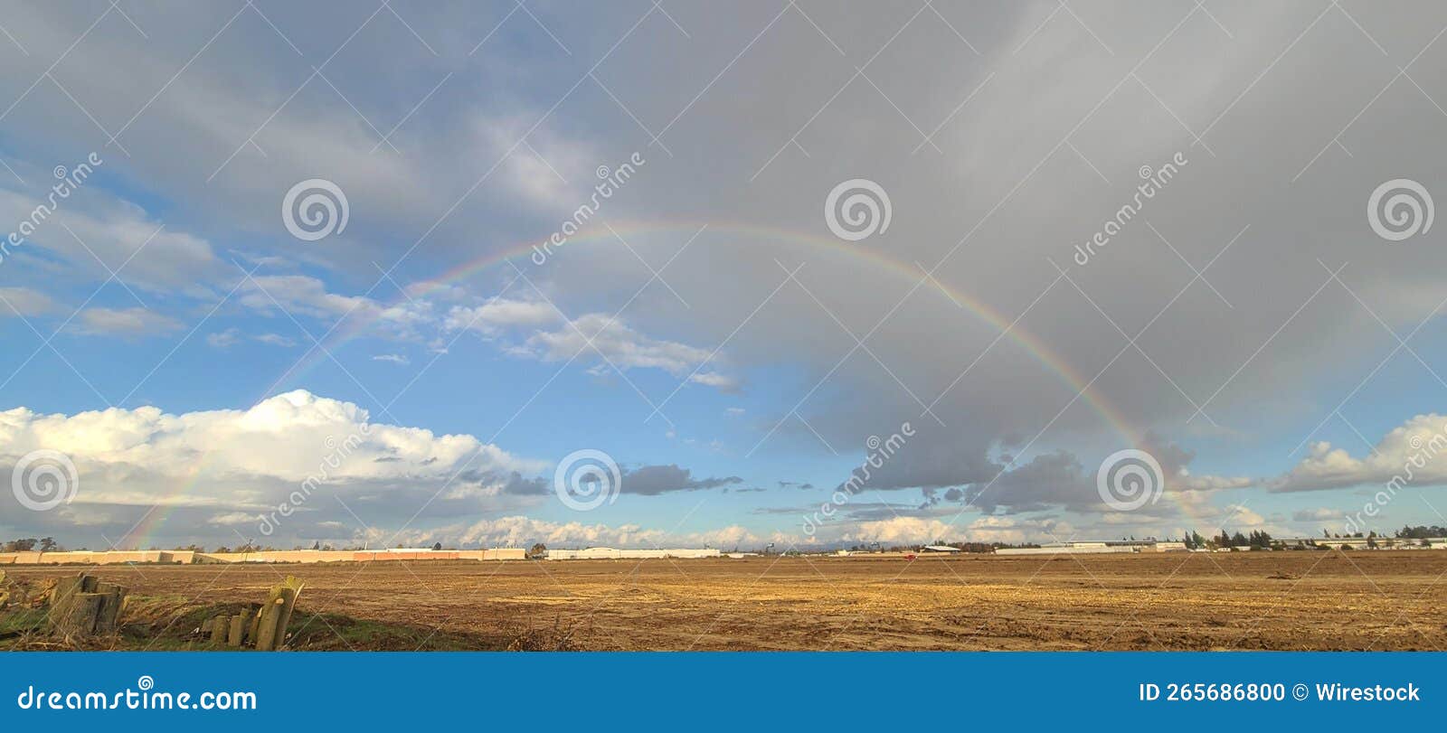 Panoramic Shot of a Rainbow Over a Field in a Rural Area Under the Sky ...
