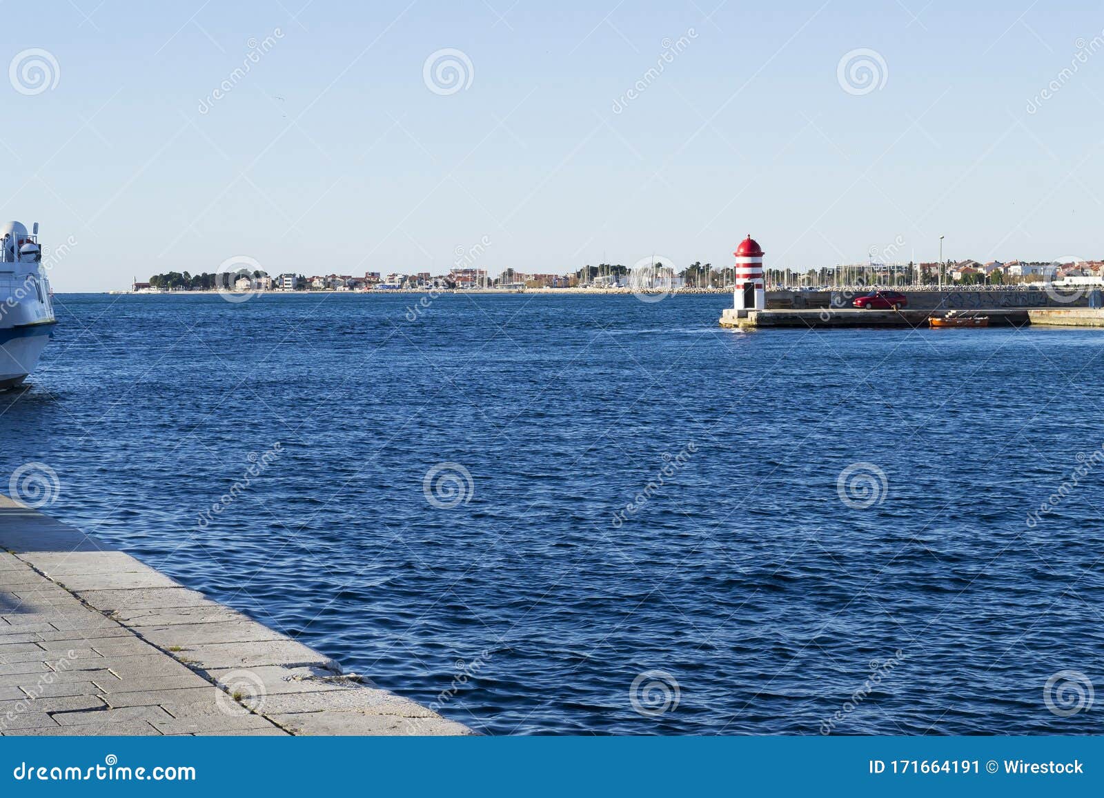 Panoramic Shot of a Seaside with a Red and White Lighthouse on a Dock ...