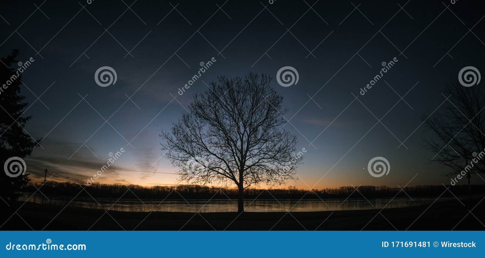 Panoramic Shot of a Sunset with a Small Lake and a Tree in the Middle ...