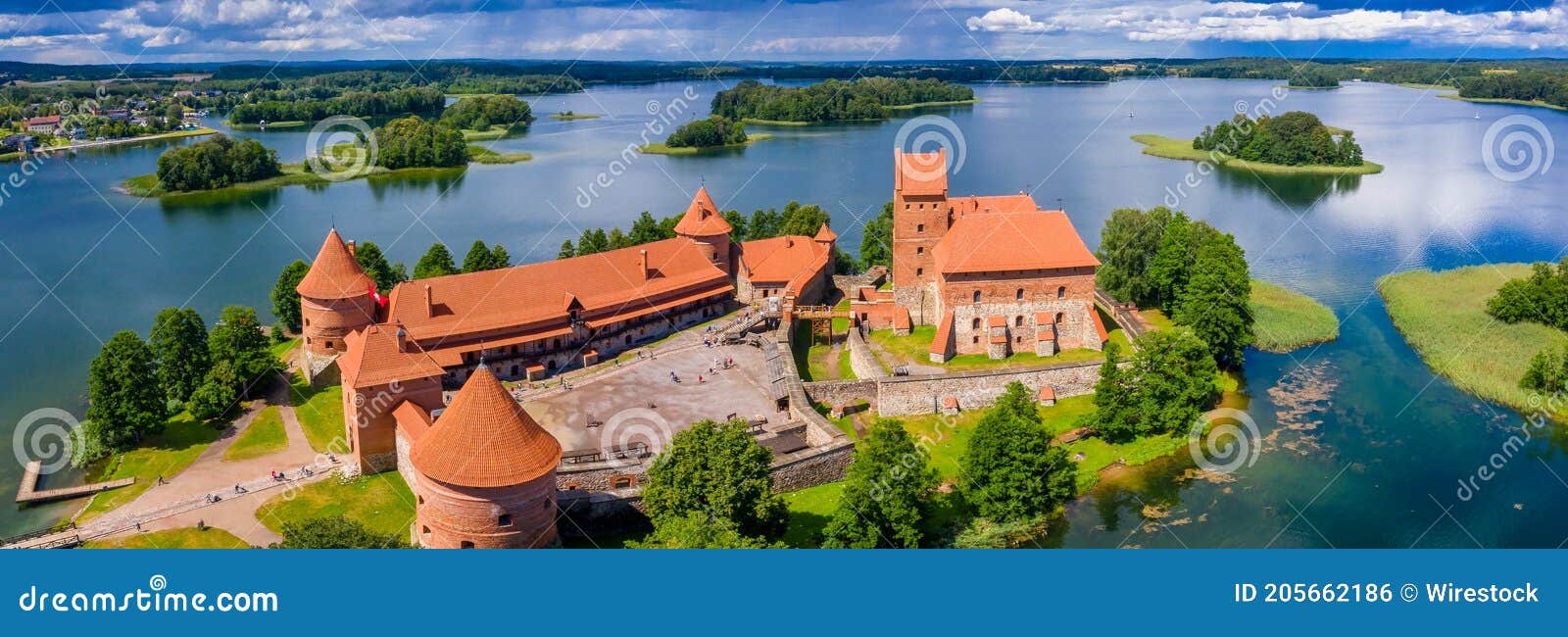 Panoramic Shot of Trakai Surrounded by Greenery and Sea Under a Blue ...