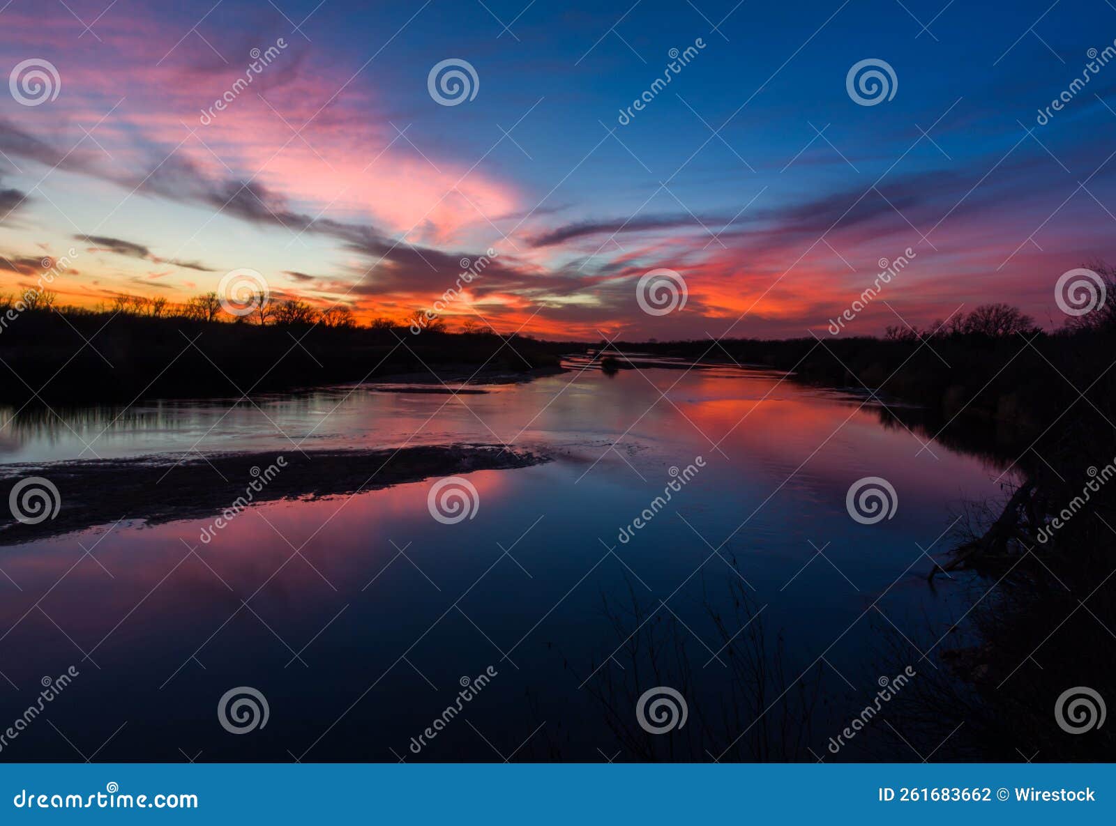 Panoramic View of a Beautiful Sunset with Trees Reflected in the ...
