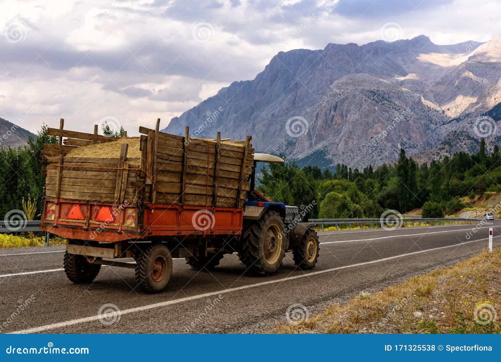 Panoramic View of the Mountain with Tractor on the Road, Forest and ...