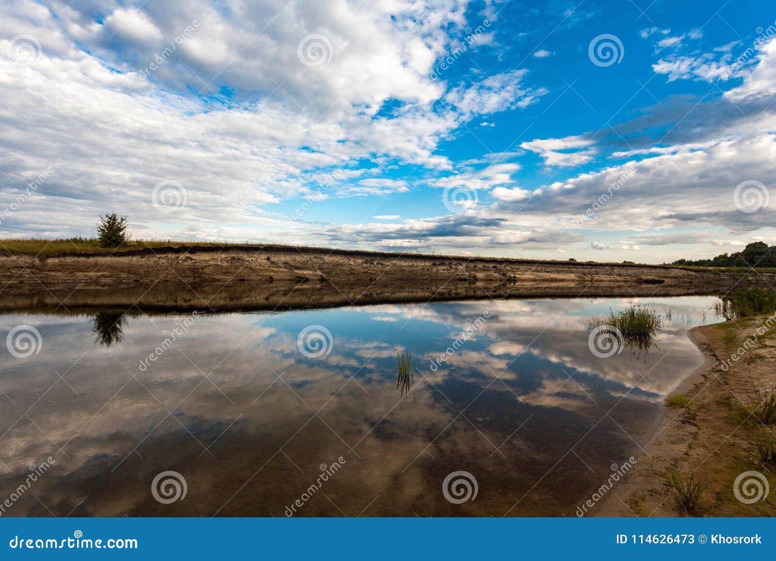 Panoramic View of Riverbank with Reflections of White Fluffy Clo Stock ...