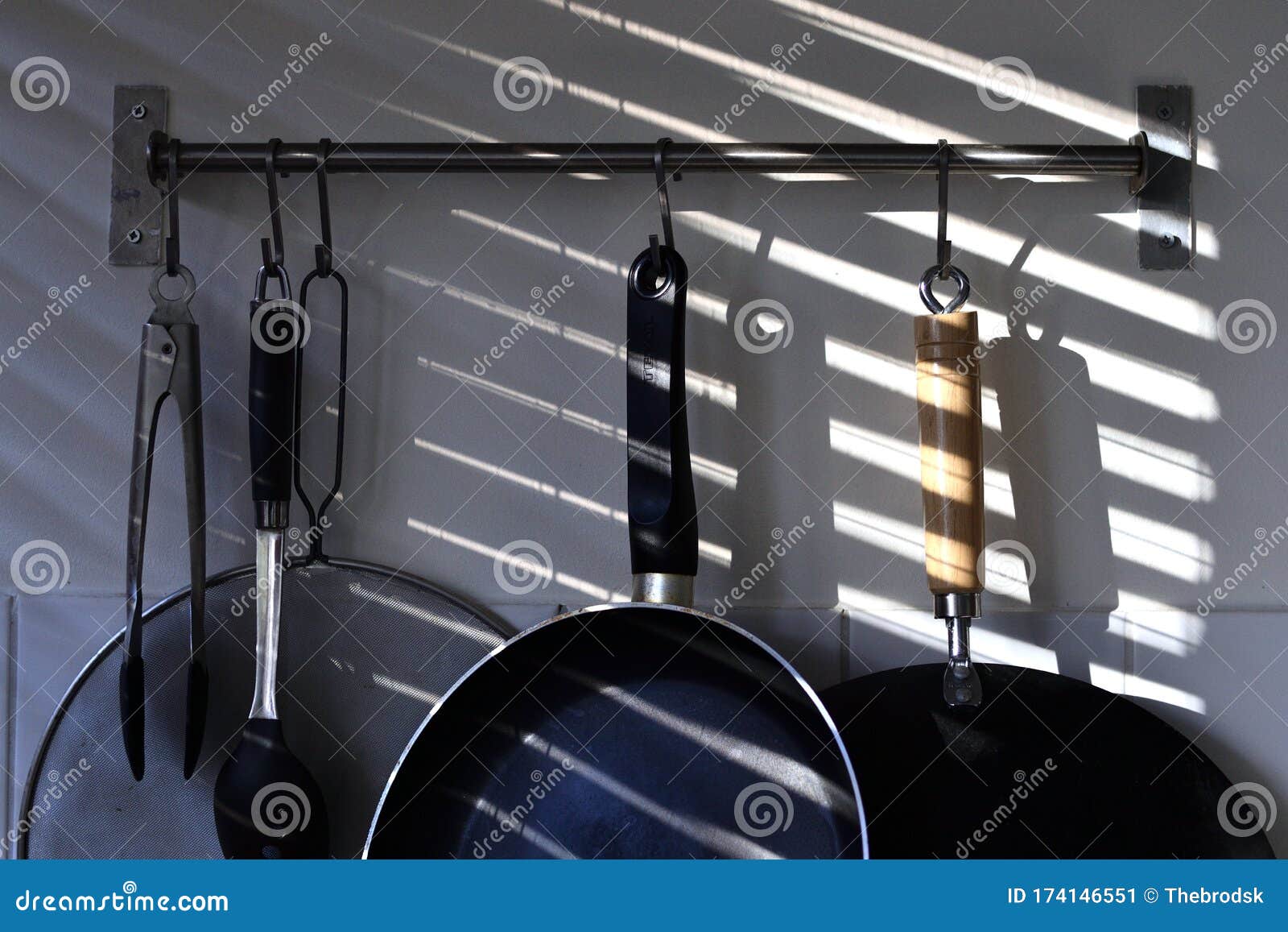 Pans and Kitchenware Hanging on a Wall Stock Image - Image of tongues ...