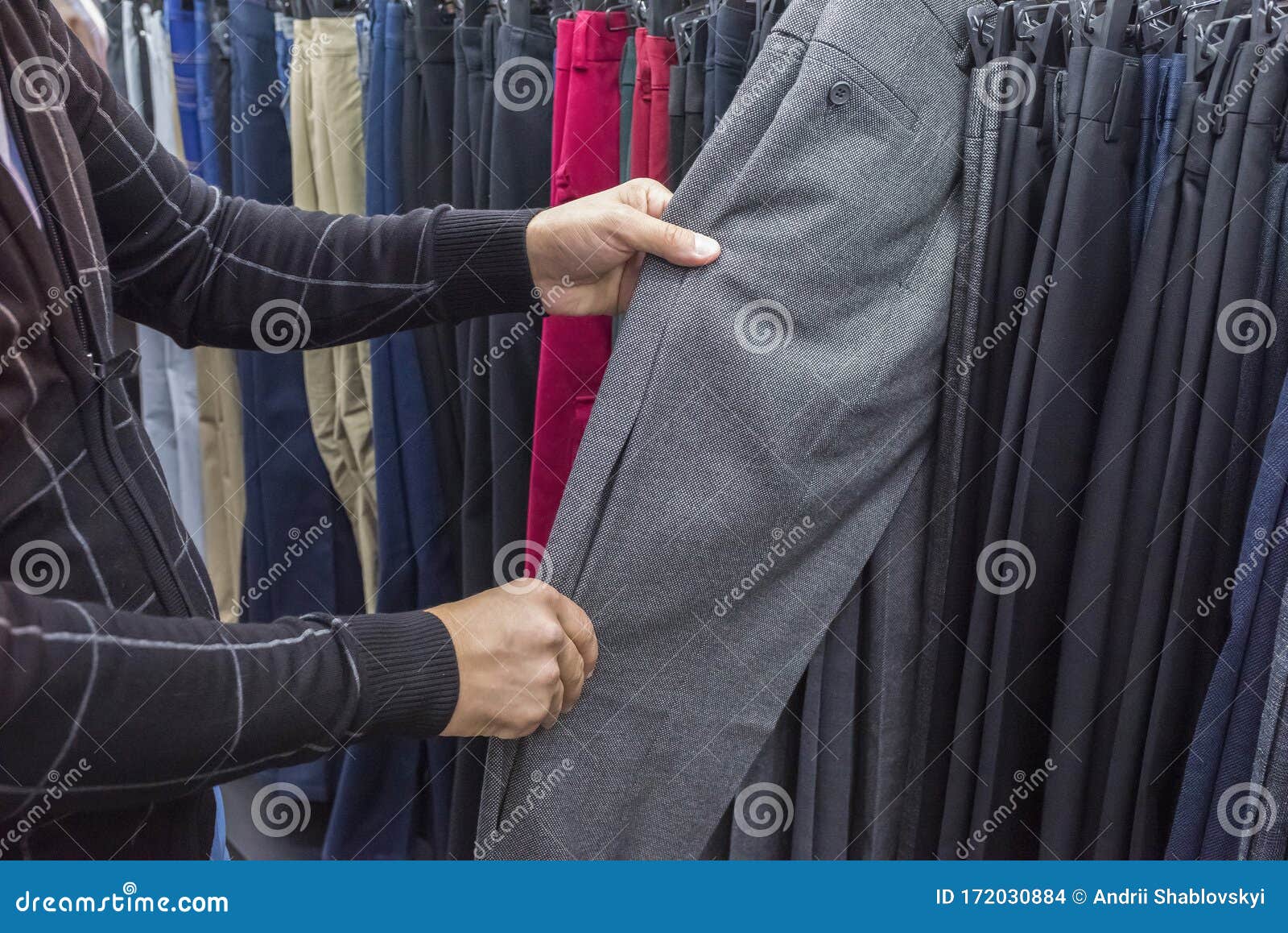 Pants in Men`s Hands in a Clothing Store, Close-up Stock Photo - Image ...