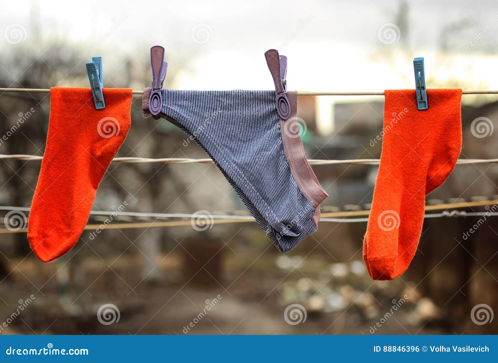 Pants and Pair of Socks Drying on the Rope Attached Colored Clothespins ...
