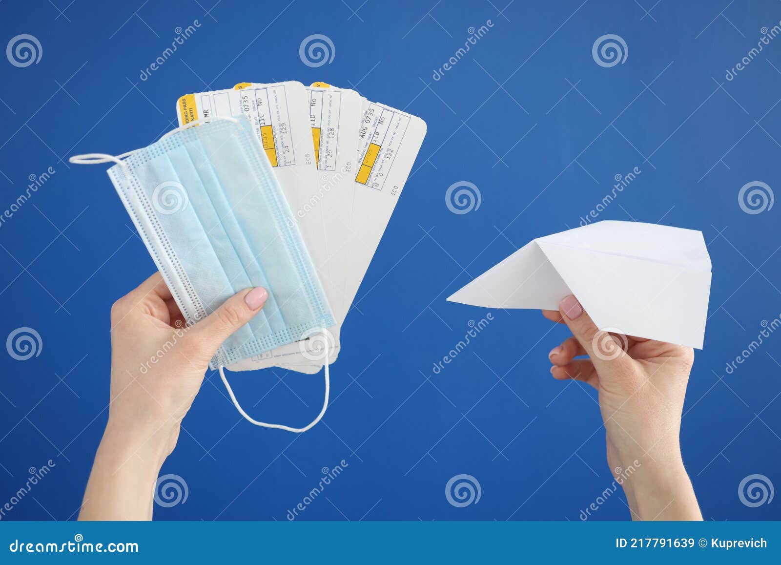 Paper Airplane With Tickets And Protective Medical Mask In Hands On