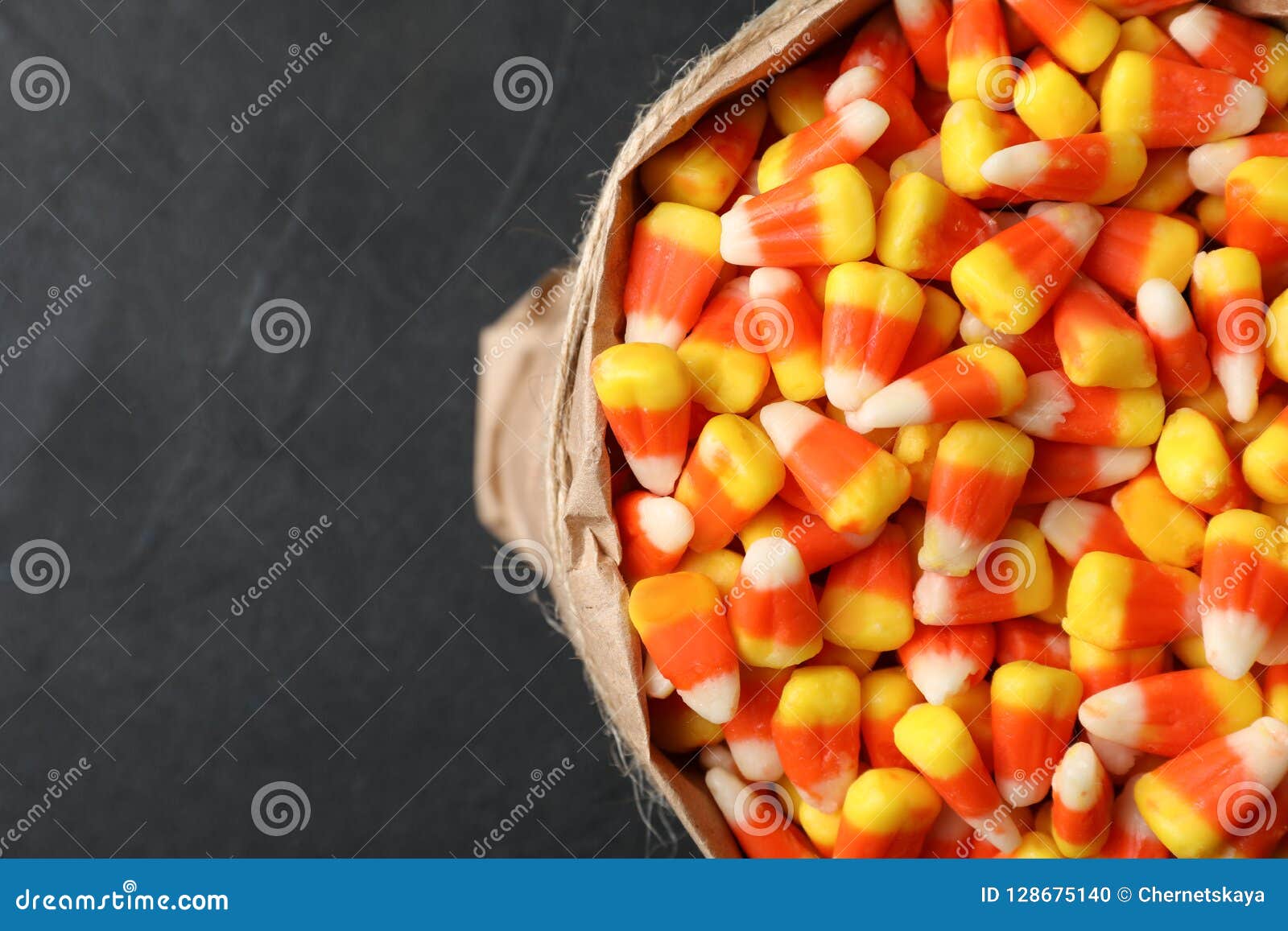Paper Bag with Tasty Candy Corns on Dark Table, Top View Stock Photo ...