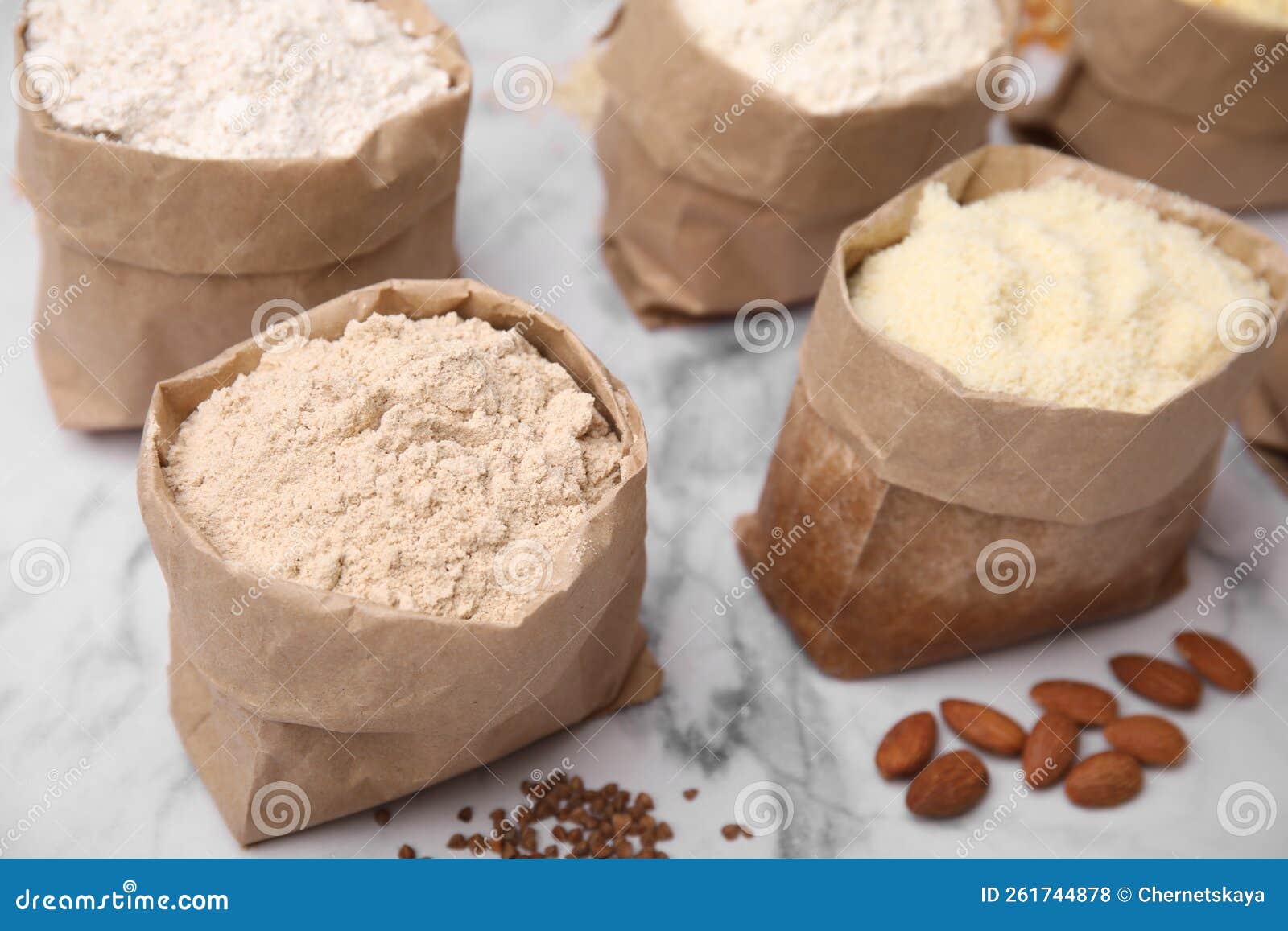 Paper Bags with Different Types of Flour and Ingredients on White ...