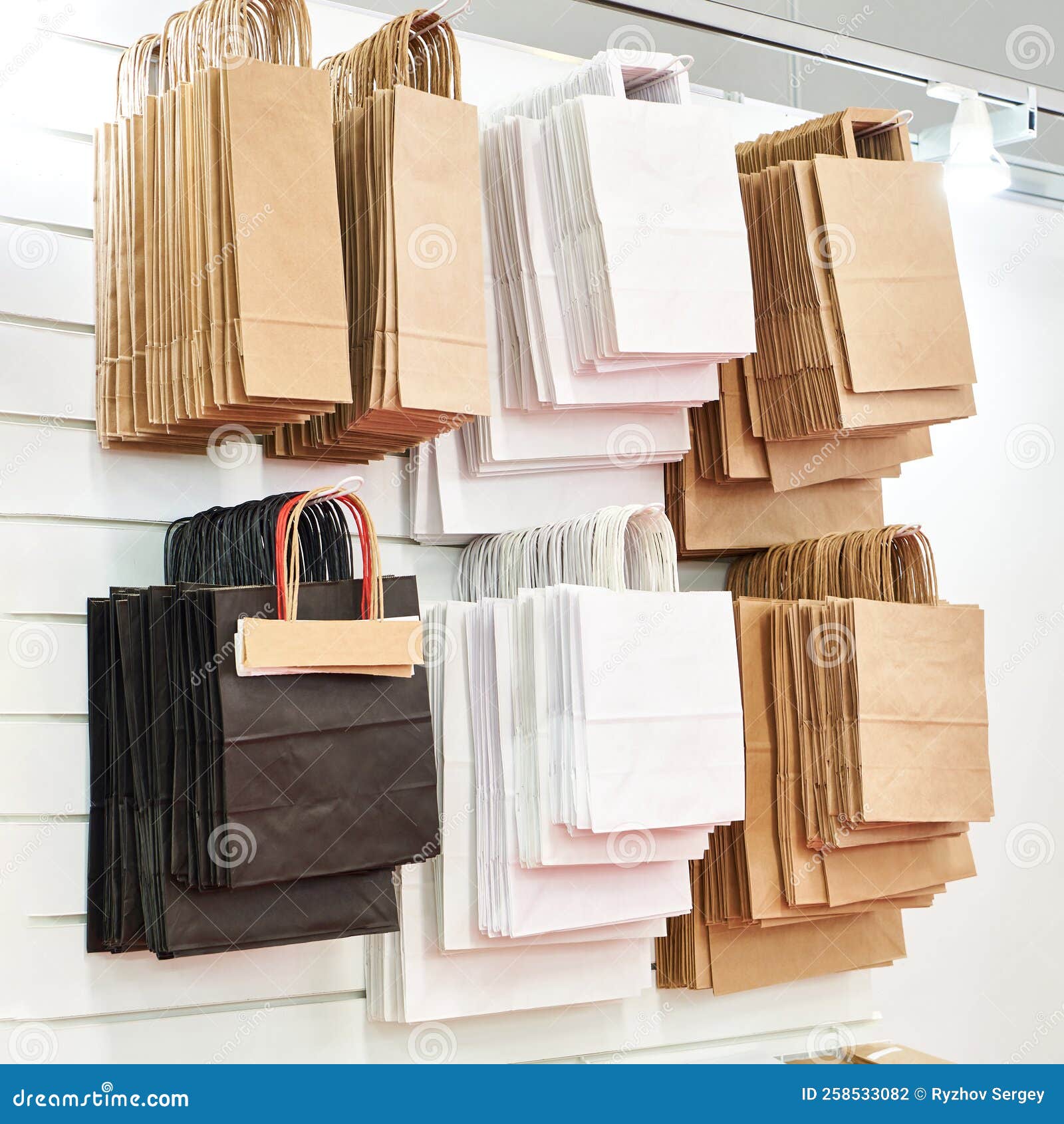 Paper bags in store stock photo. Image of market, consumerism - 258533082