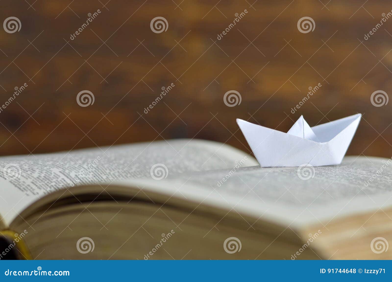 Paper boat on the book stock photo. Image of adventure - 91744648