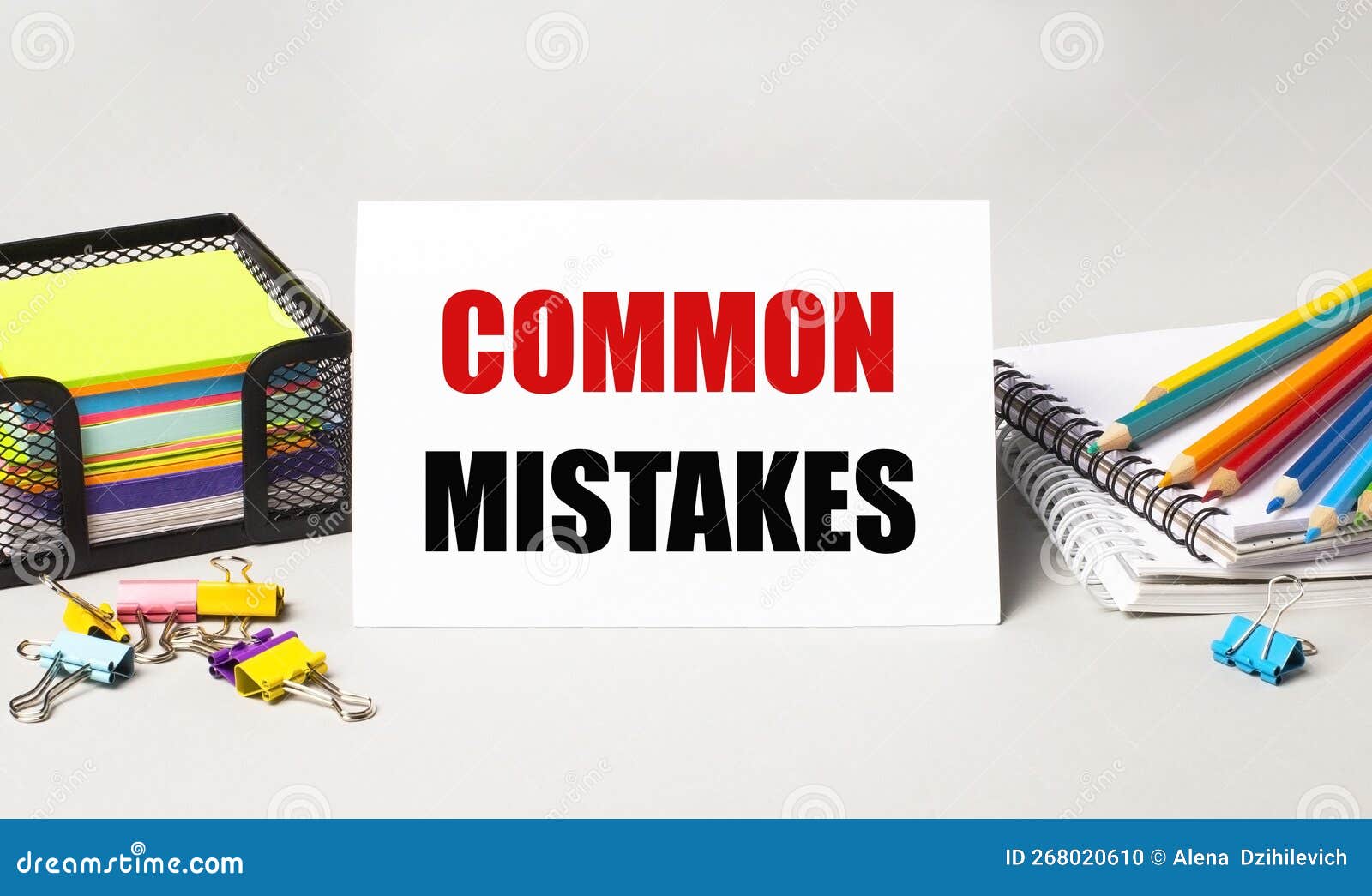 A Paper Card with the Text COMMON MISTAKES, Multi-colored Pencils ...