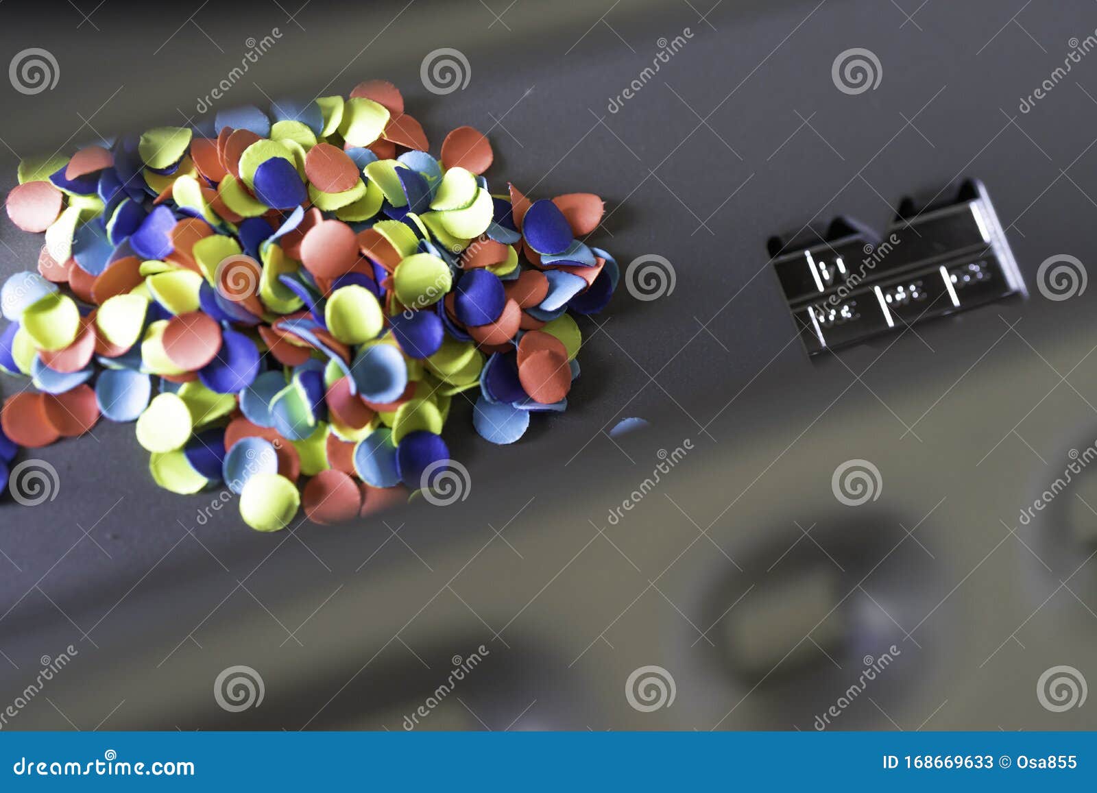 Paper Chads Produced by Punching Holes in a Sheets of Colored Paper ...