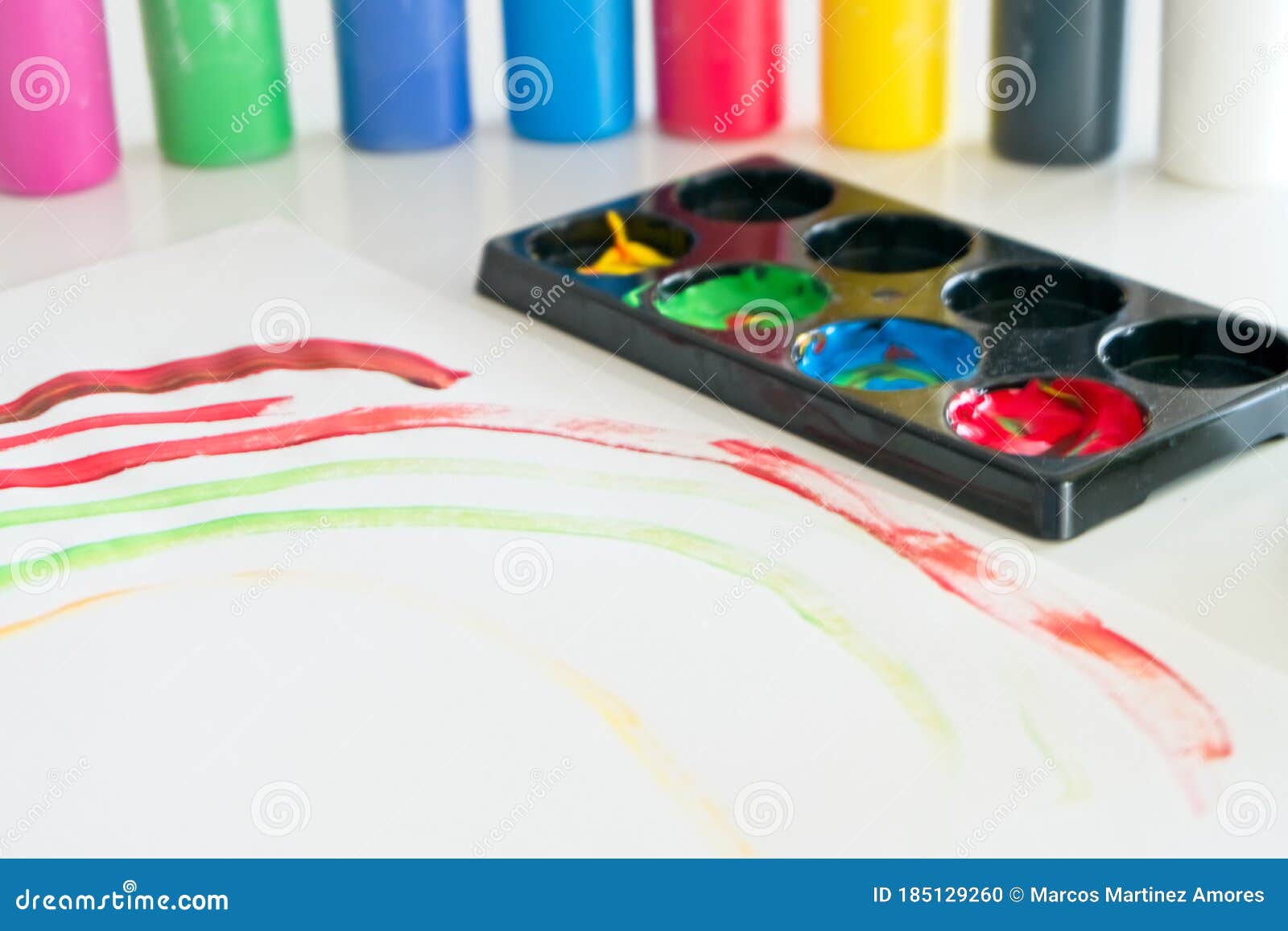 Paper with a Child`s Drawing with Several Containers of Tempera Paint ...