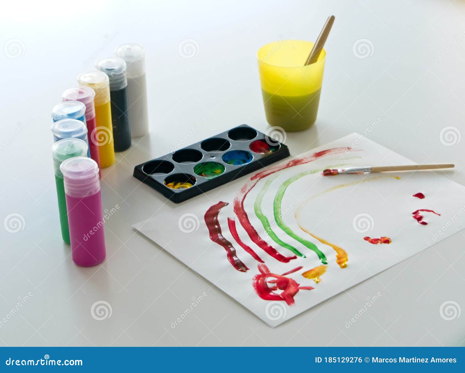 Paper with a Child`s Drawing with Several Containers of Tempera Paint ...