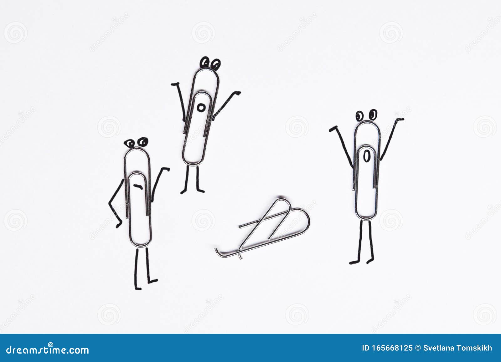 Paper Clips are Lying on a White Surface - One of the Paper Clips is ...