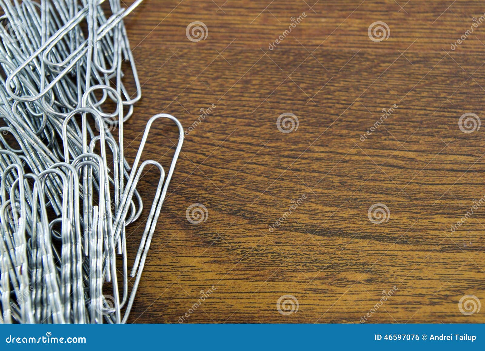 Paper clips on wood desk stock photo. Image of binder - 46597076