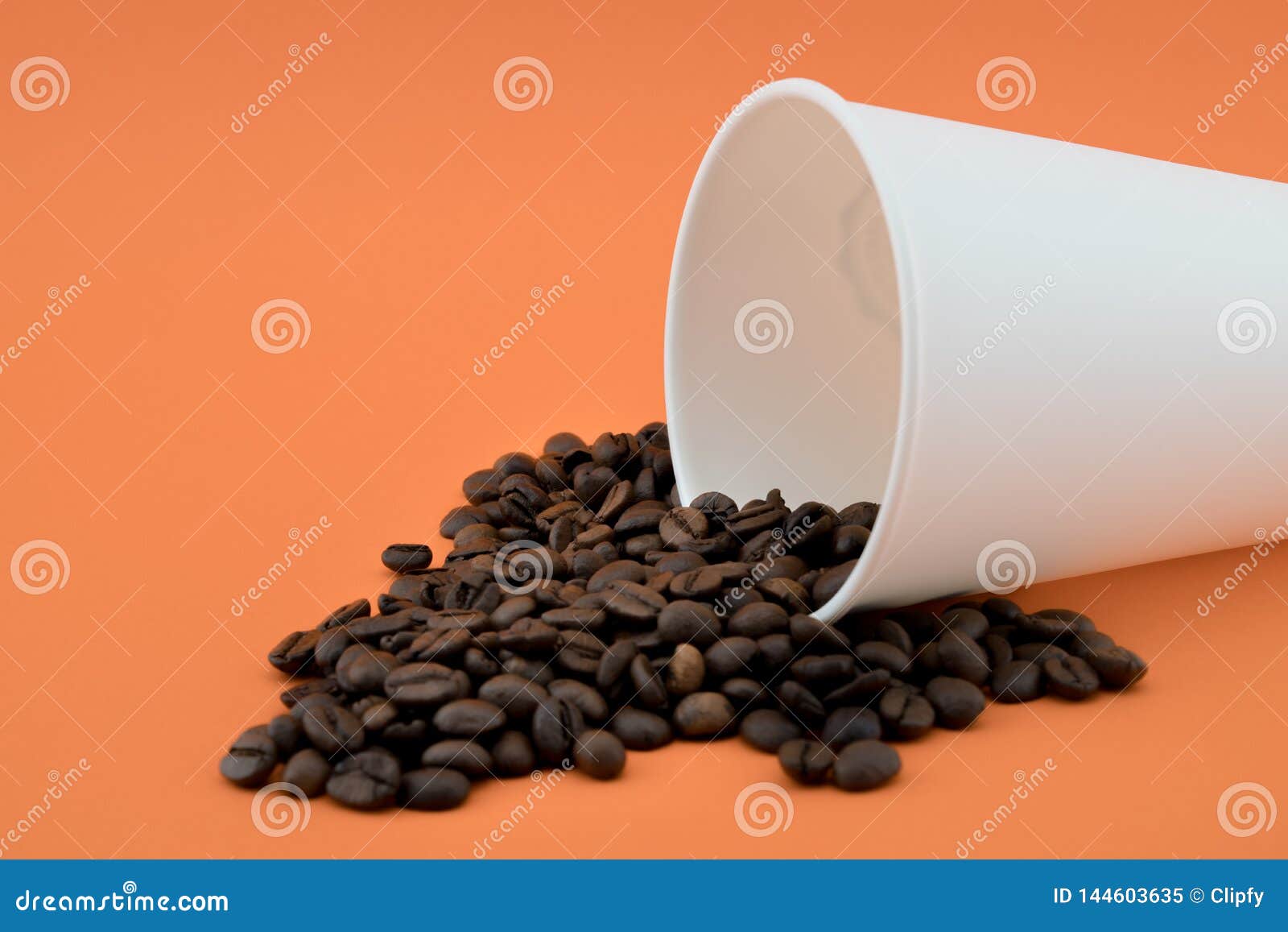 Paper Coffee Cup with Spilled Coffee Beans, Orange Background. Coffee ...