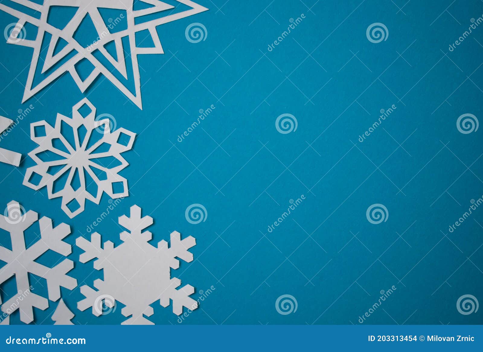 Paper Cut Handmade White Snowflakes on Light Blue Background Stock ...