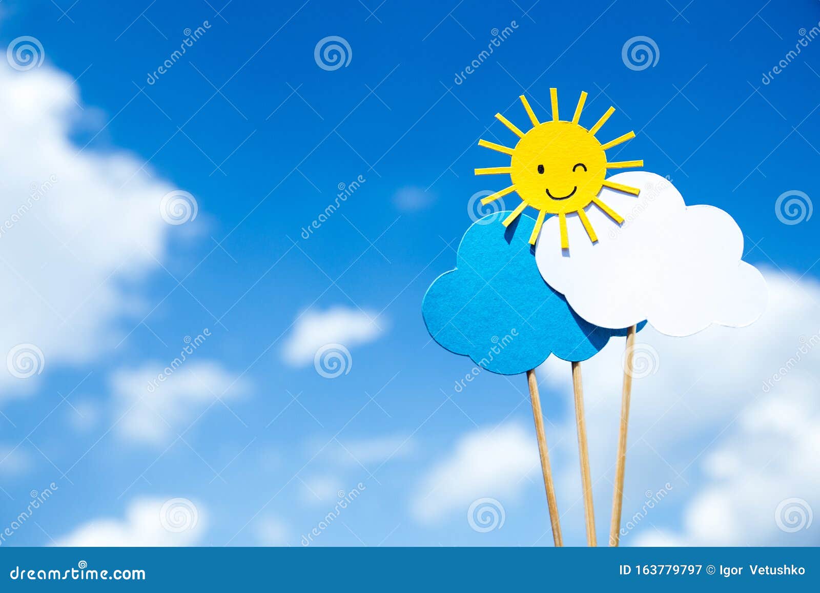 Paper Cut Winking Sun and Blue and White Clouds on Sticks Stock Image ...
