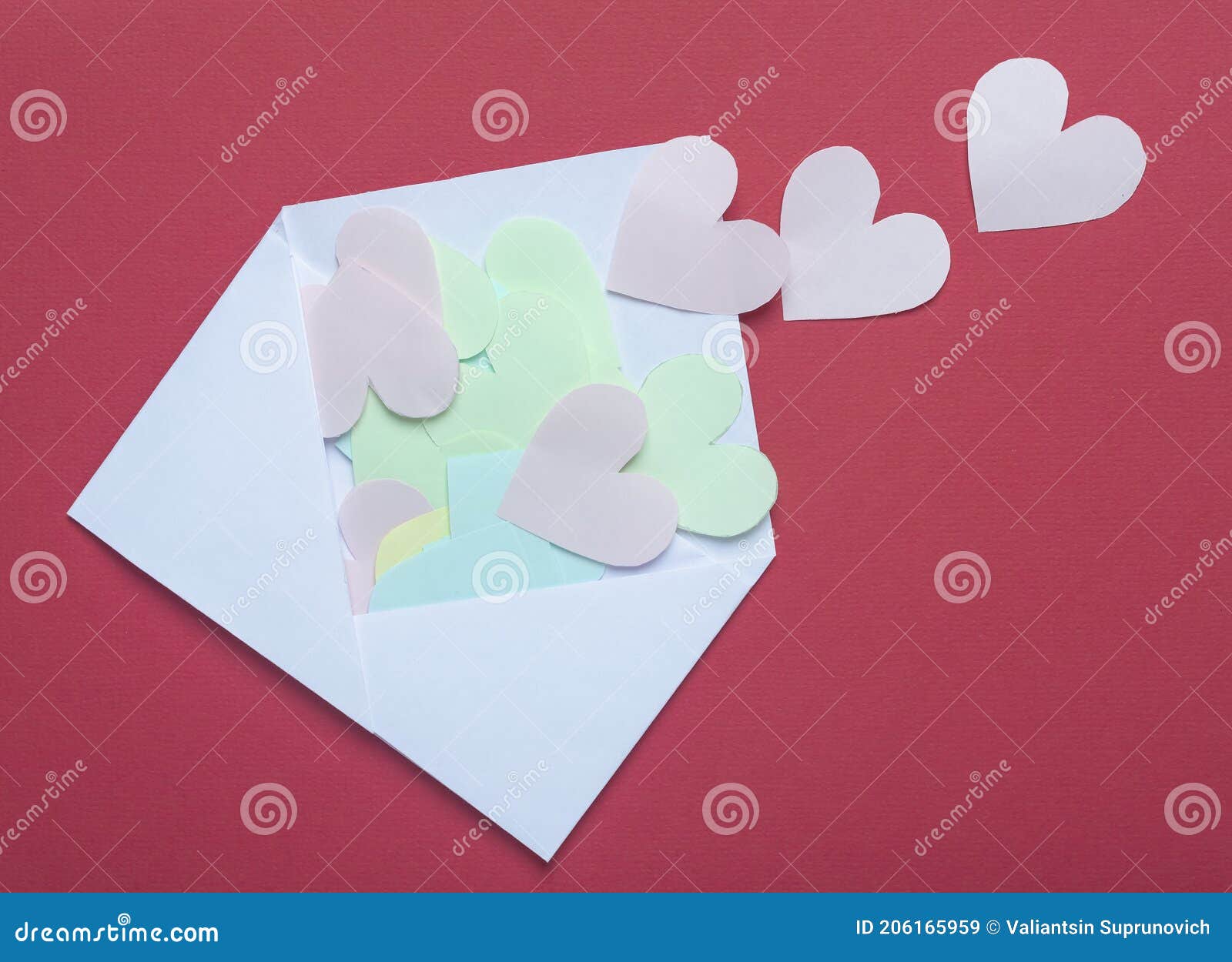 Paper Hearts of Different Color Scattered from White Envelope Over Red ...