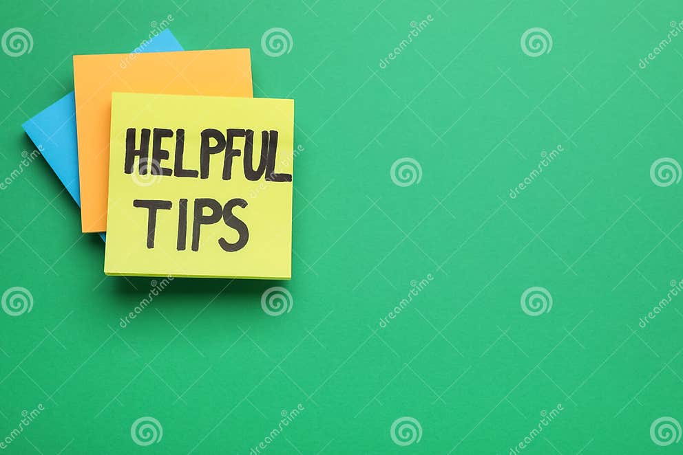 Paper Note with Phrase Helpful Tips on Green Background, Top View ...