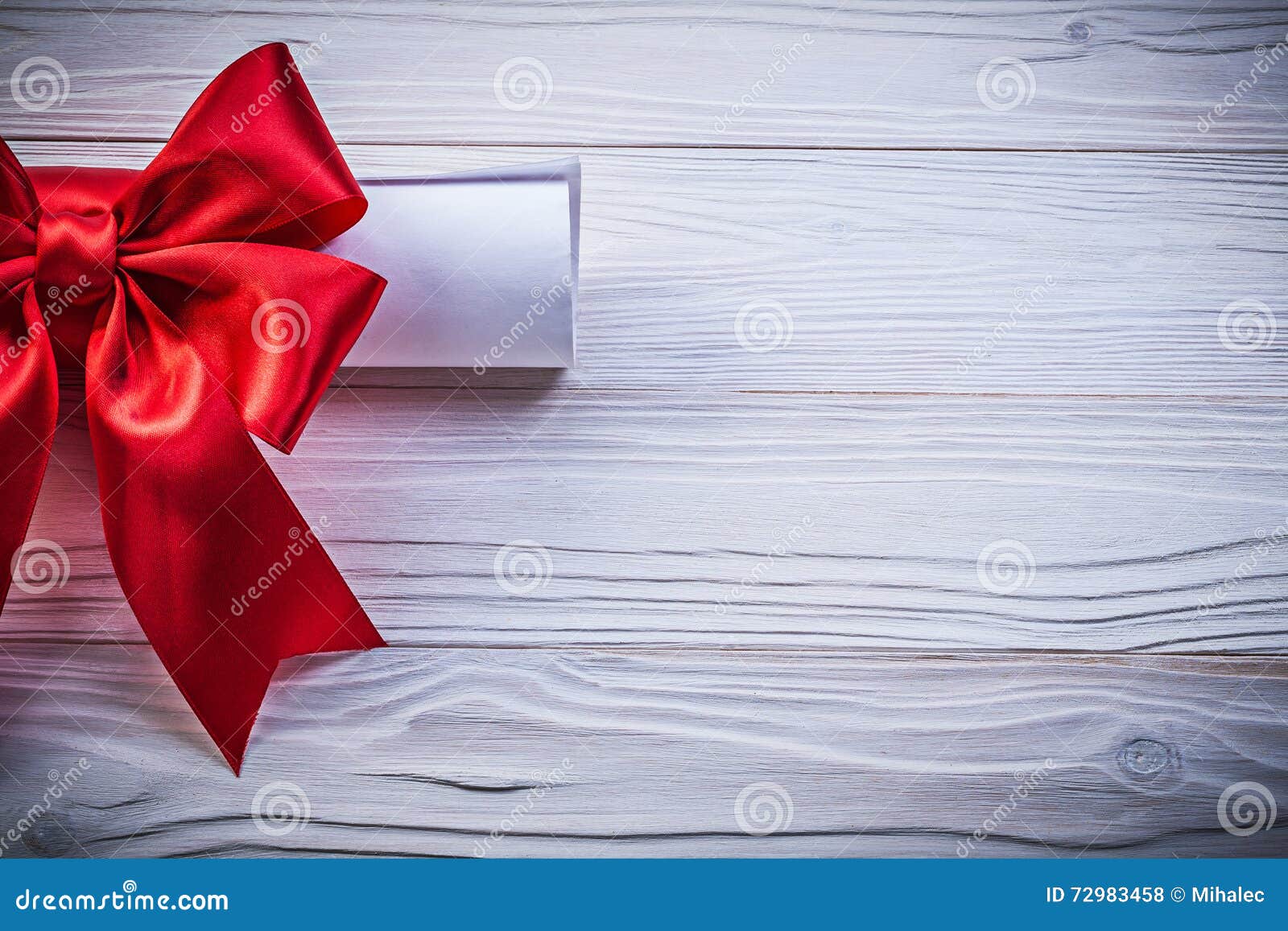 Paper Scroll with Red Bow on Wooden Board Holidays Concept Stock Photo ...