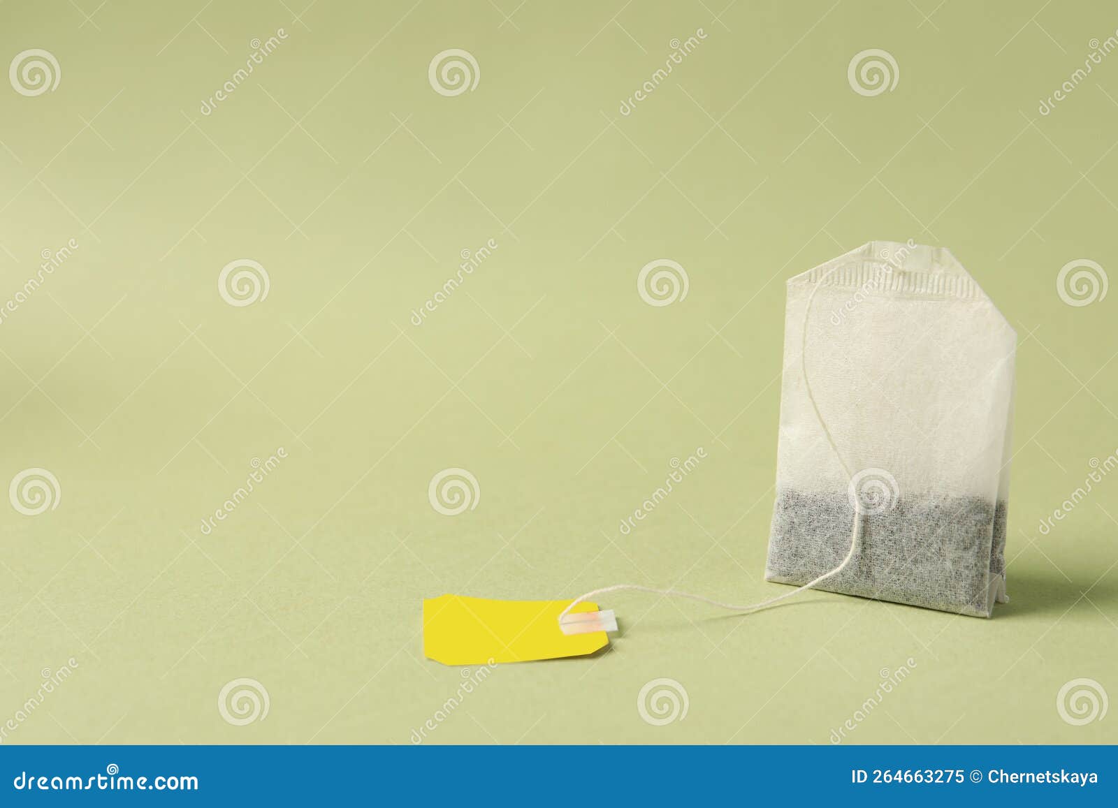 Paper Tea Bag with Tag on Light Green Background, Space for Text Stock ...