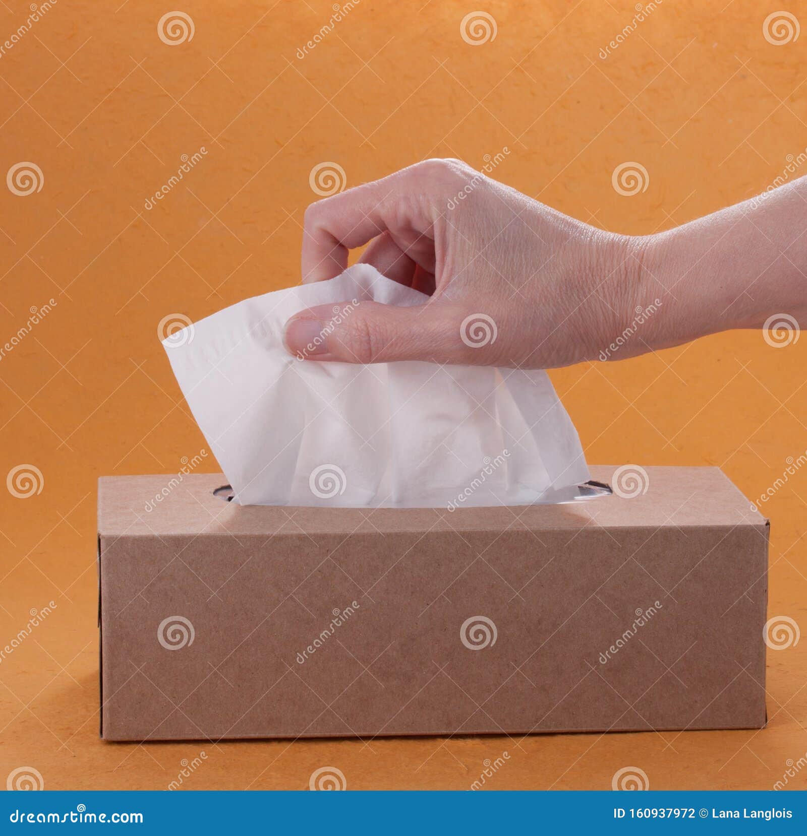 Paper Tissue Box on Orange Background Stock Photo - Image of hand ...