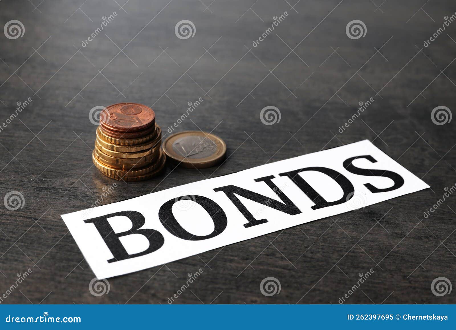 Paper with Word Bonds and Stacked Coins on Grey Table Stock Image ...