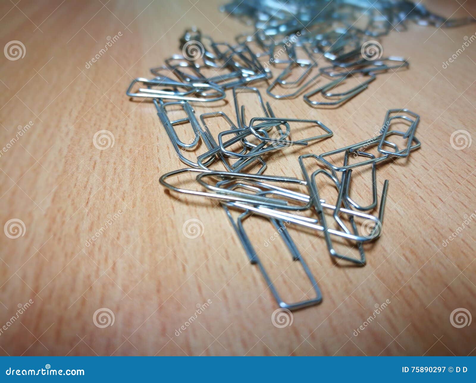 Paperclips on a Wooden Desk Stock Image - Image of ordinary, desk: 75890297