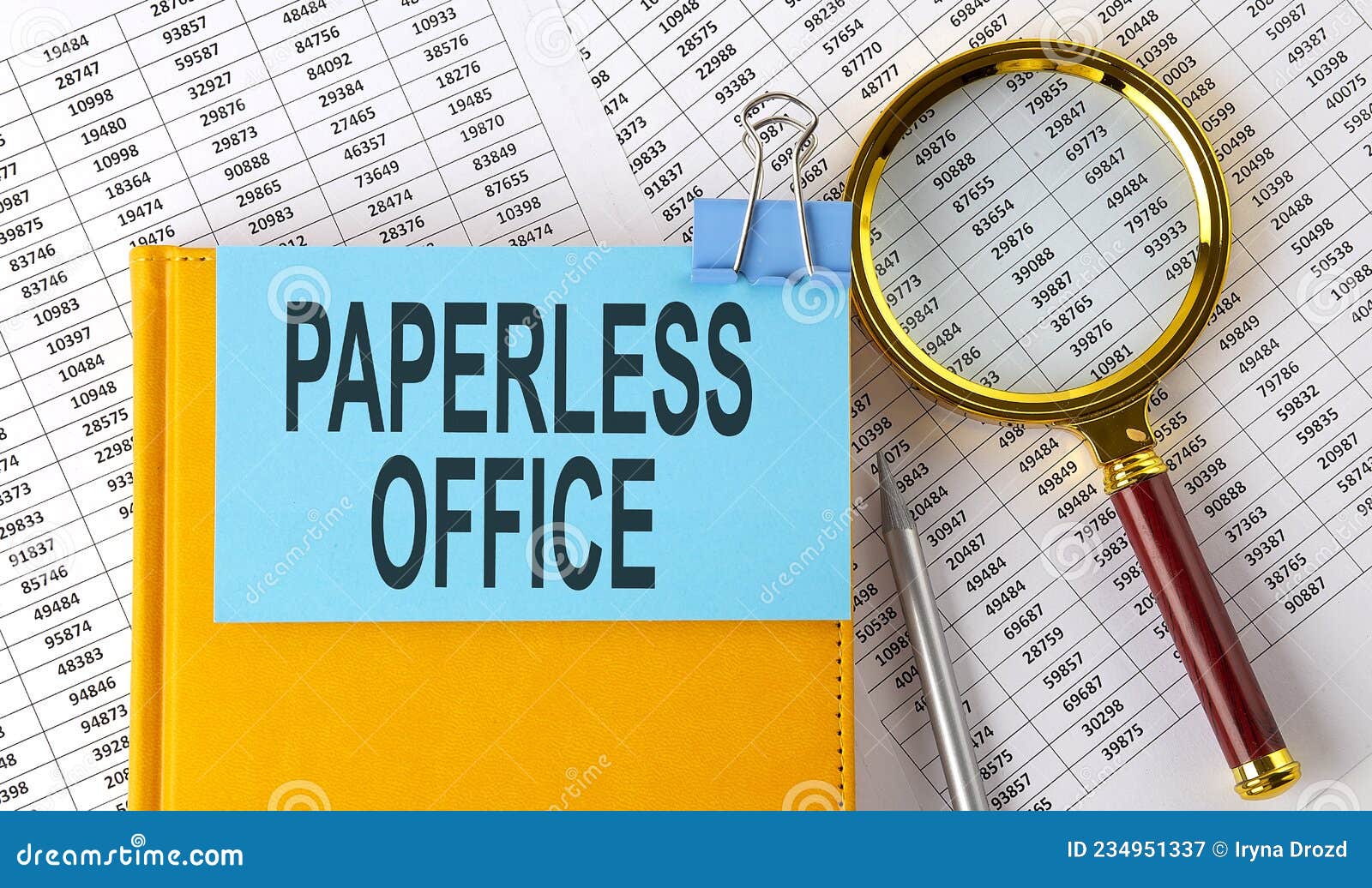 PAPERLESS OFFICE Text on Sticker on Notebook with Magnifier and Chart ...