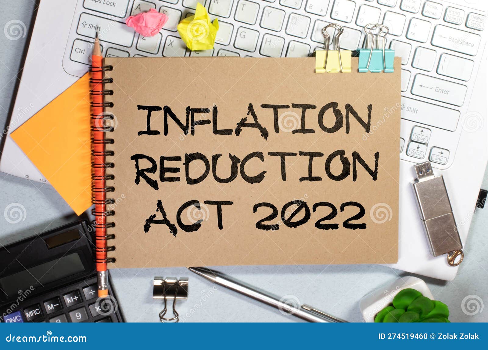 Papers with Inflation Reduction Act of 2022 and Notepad Stock Photo ...