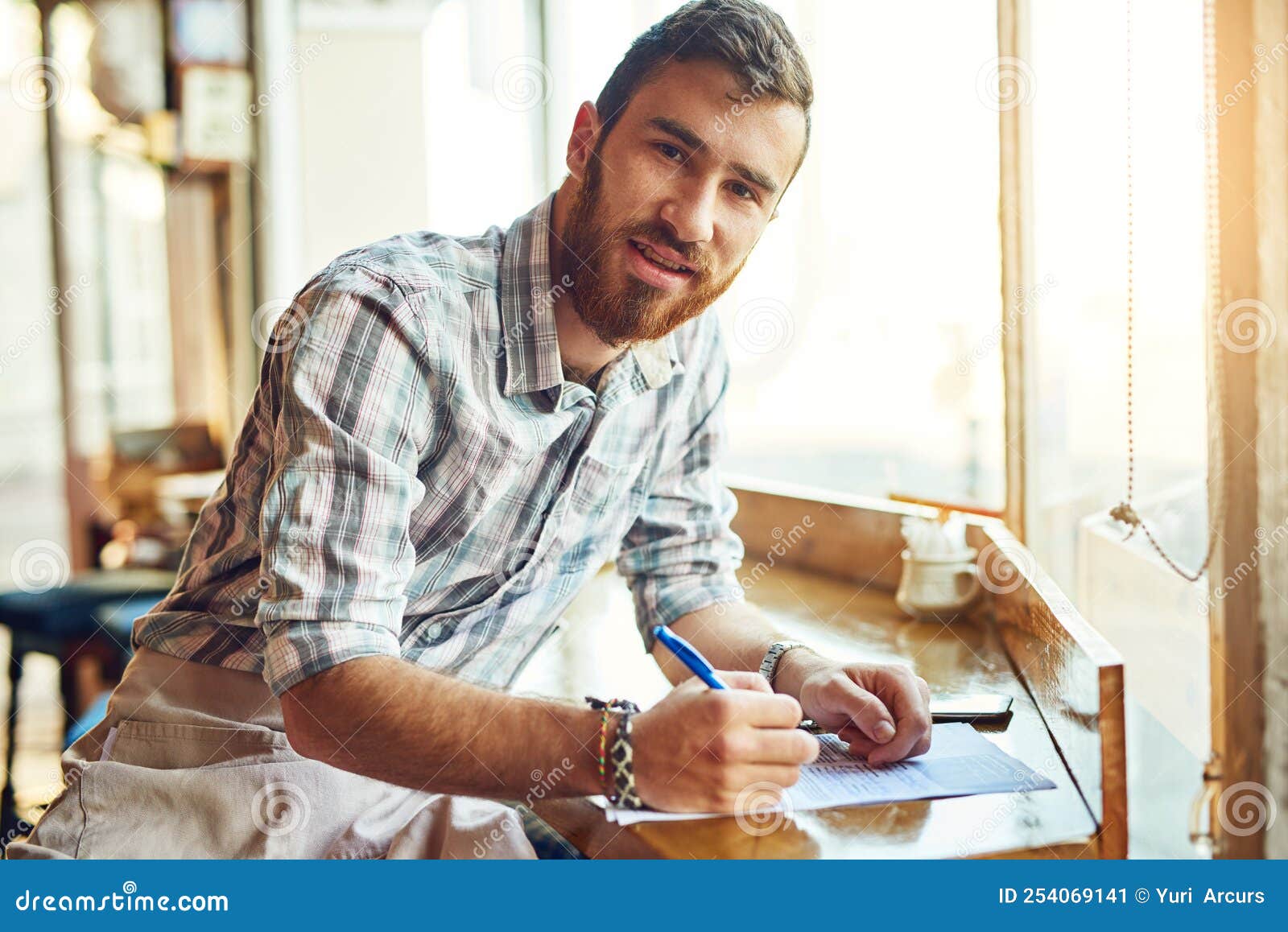 That Paperwork Finally Came through. a Shop Owner Doing Some Paperwork ...