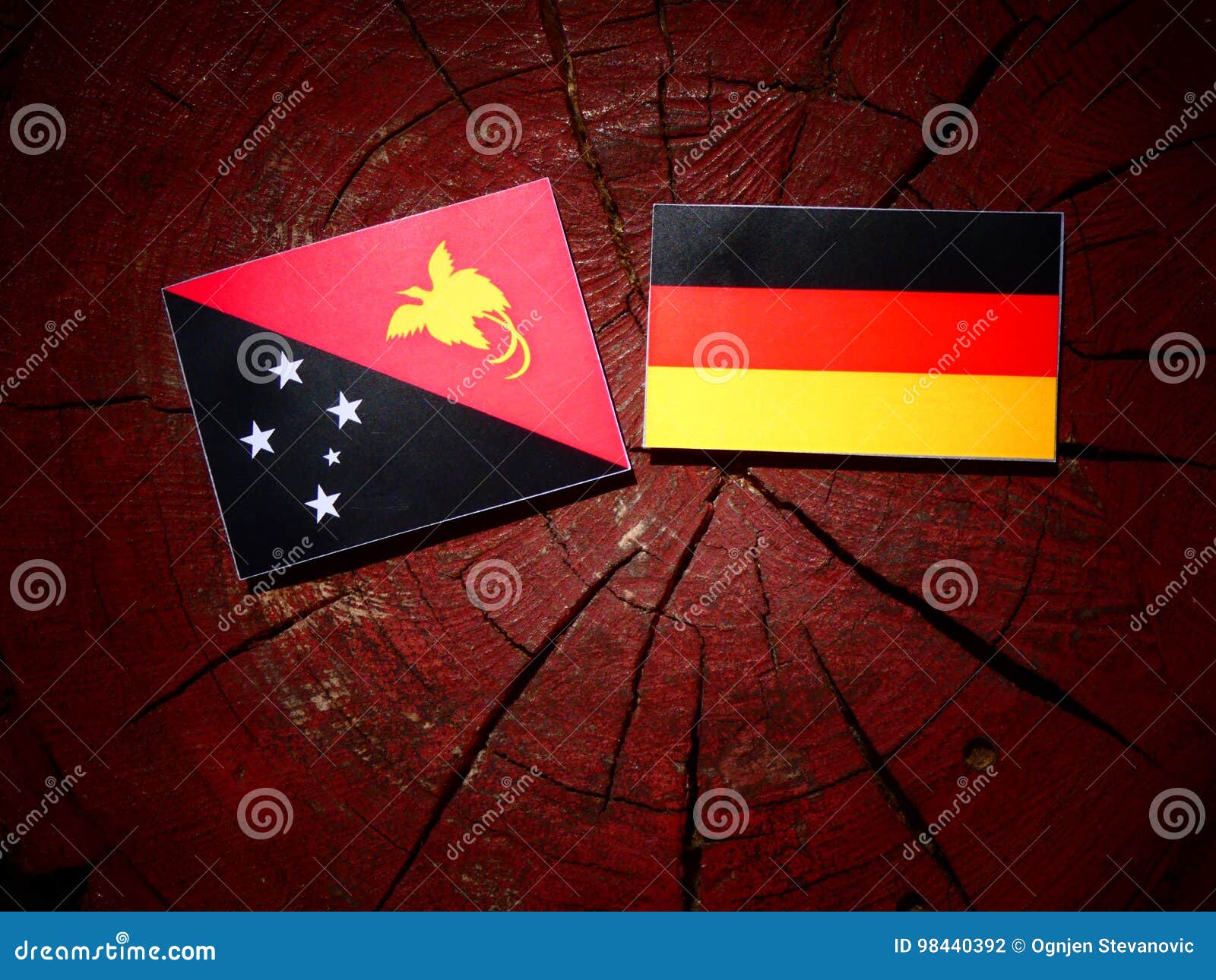 Papua New Guinea Flag with German Flag on a Tree Stump Stock Photo ...