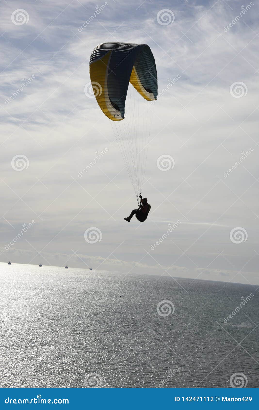 Paraglider over ocean stock photo. Image of alone, water - 142471112