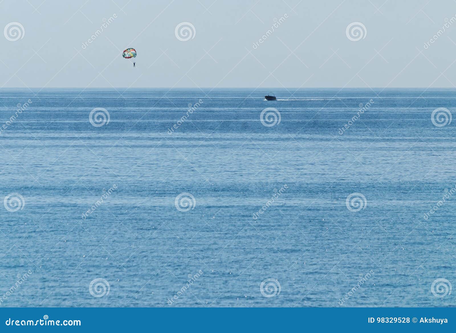 Parachute Flight Over the Sea Stock Photo - Image of blue, parachute ...