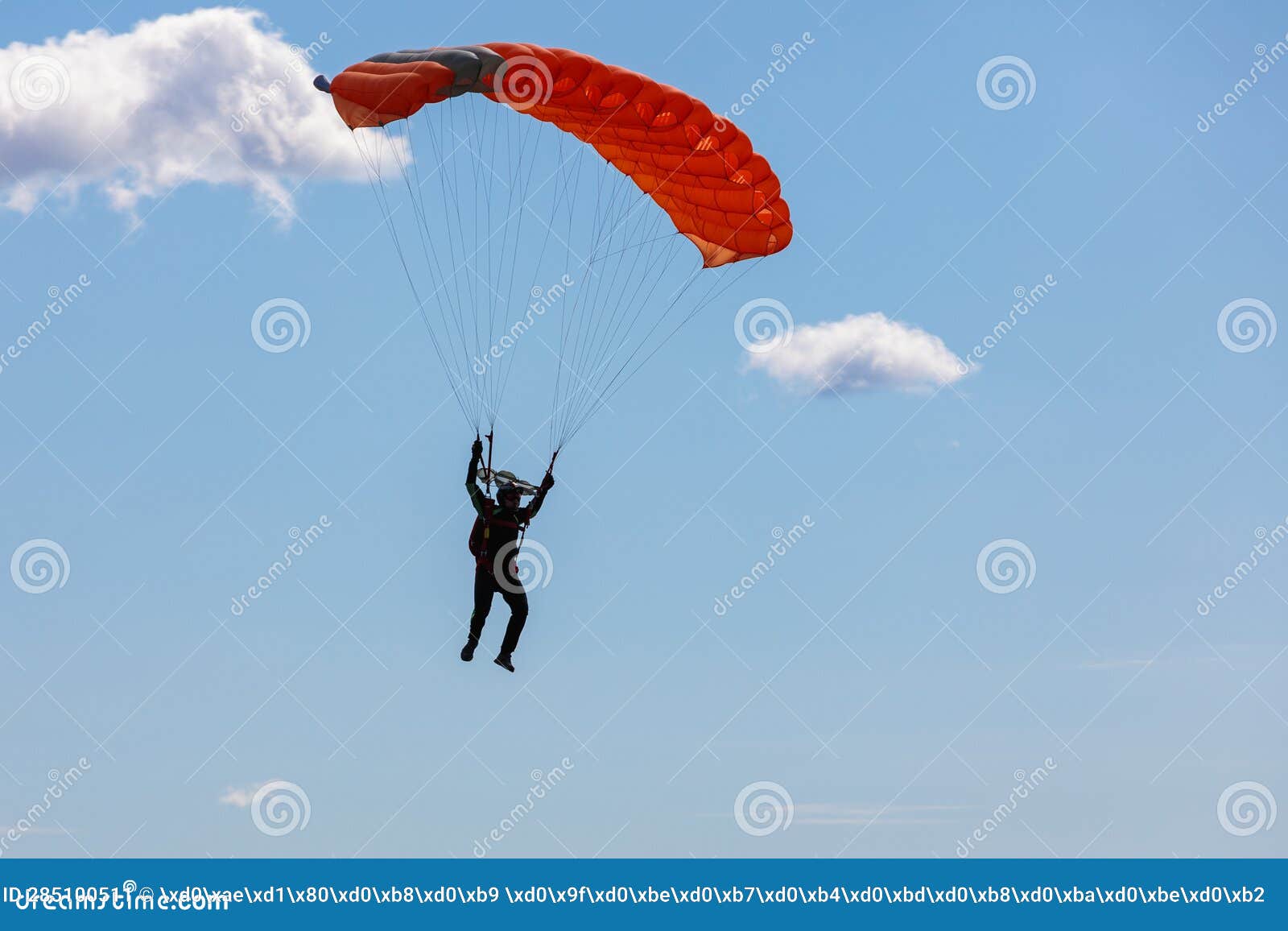 Parachute in the Sky. Skydiver is Flying a Parachute in the Blue Sky ...