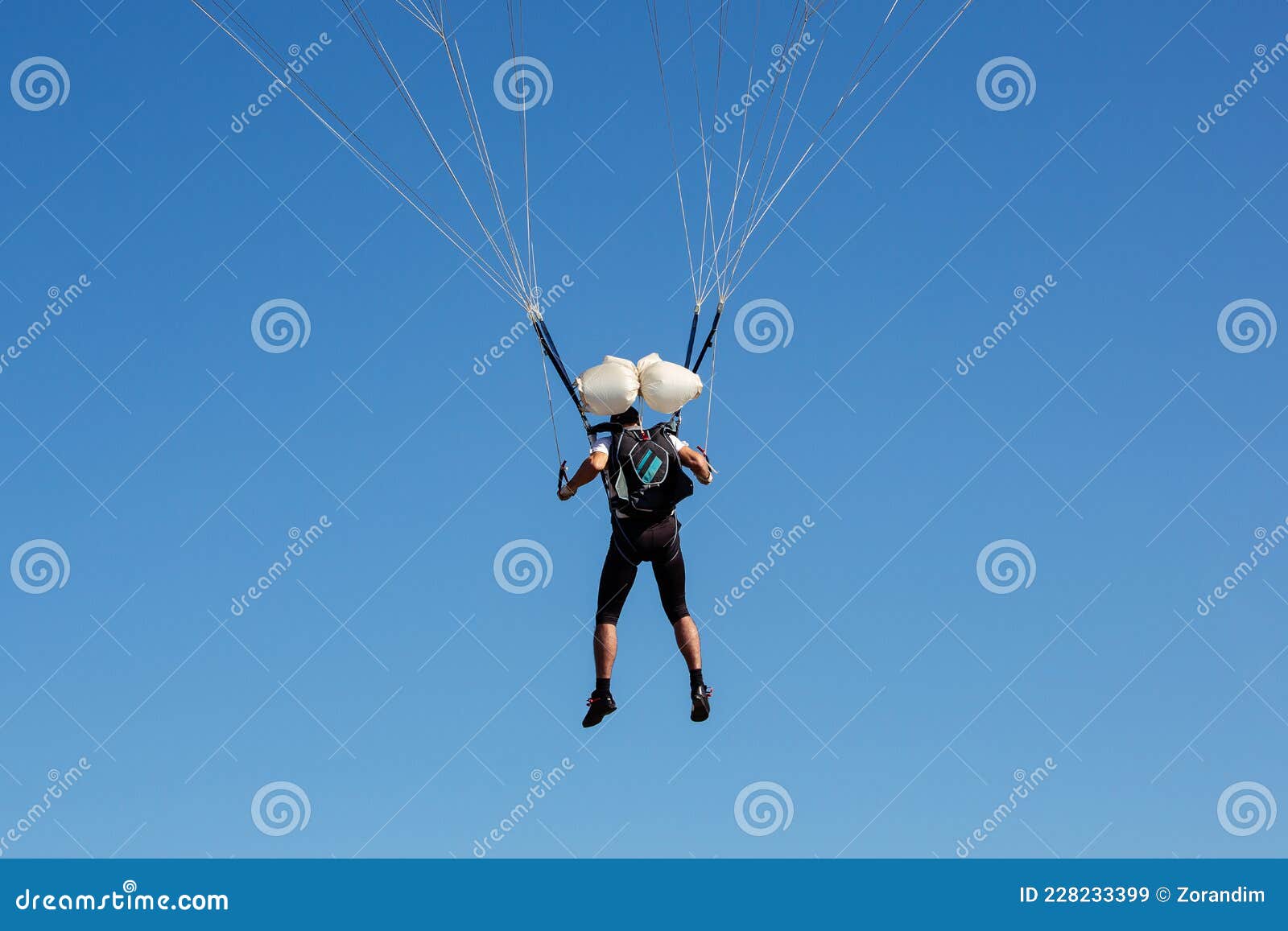 Parachute in the Sky. Skydiver is Flying a Parachute in the Blue Sky ...