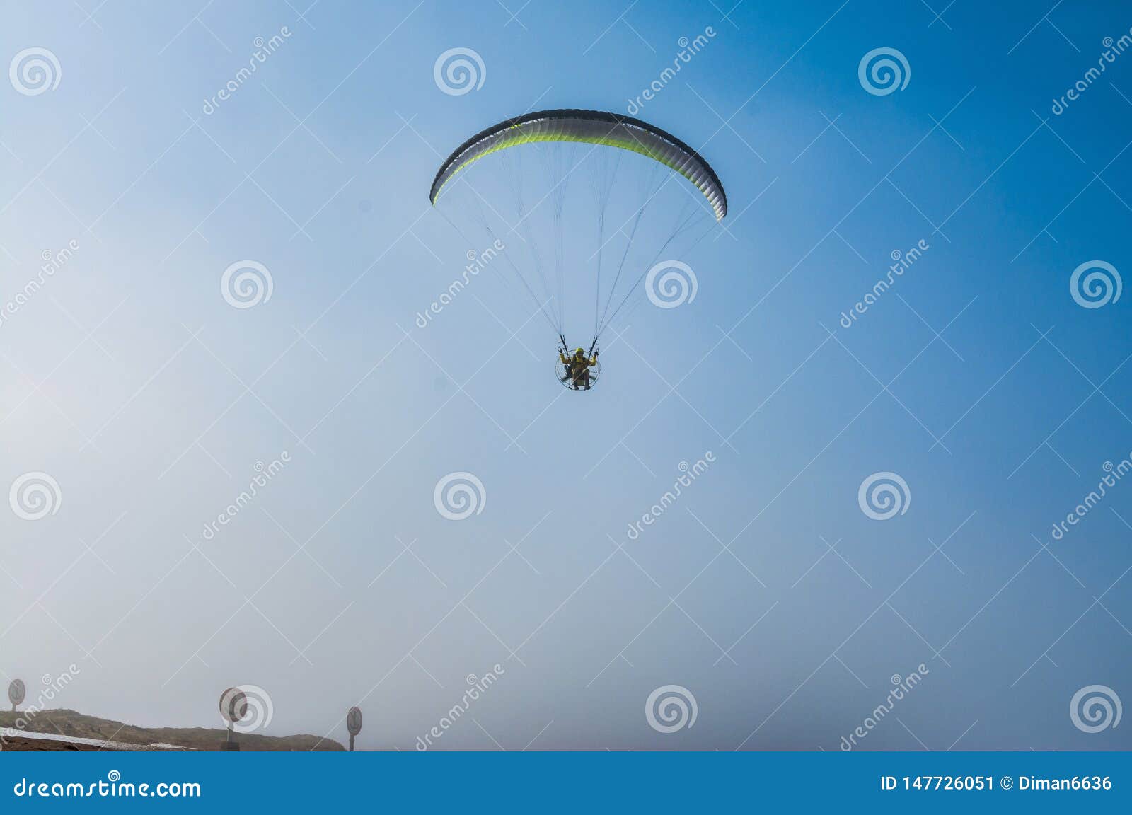 Parachutist Flies Against the Blue Sky. Motorized Parachute Stock Image ...