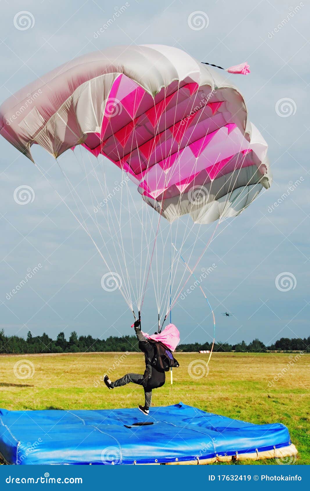 Parachutist Landing Under a Pink Parachute Stock Image - Image of ...