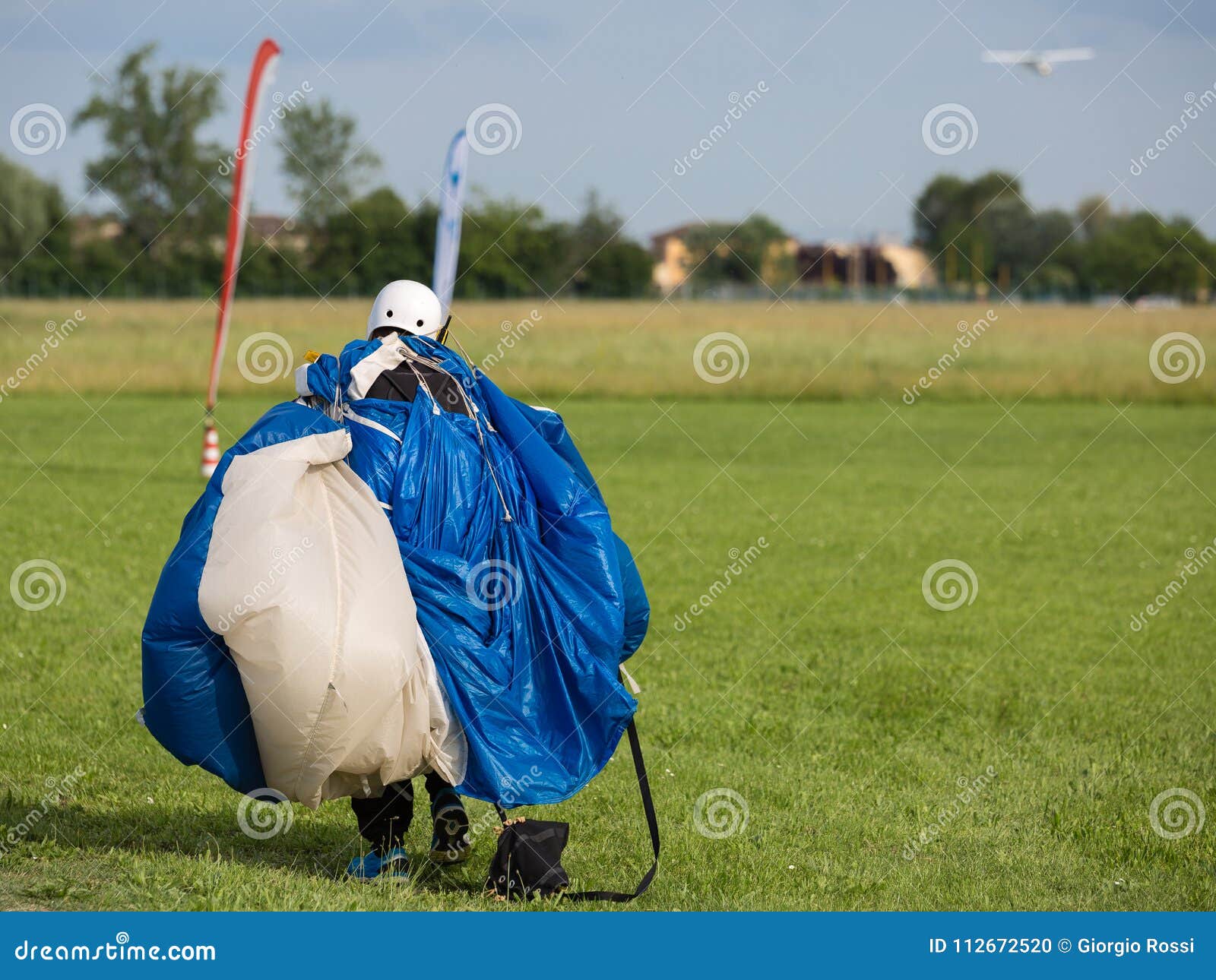 Parachutist with Parachute on Shoulders Coming Back To Base-Point after ...