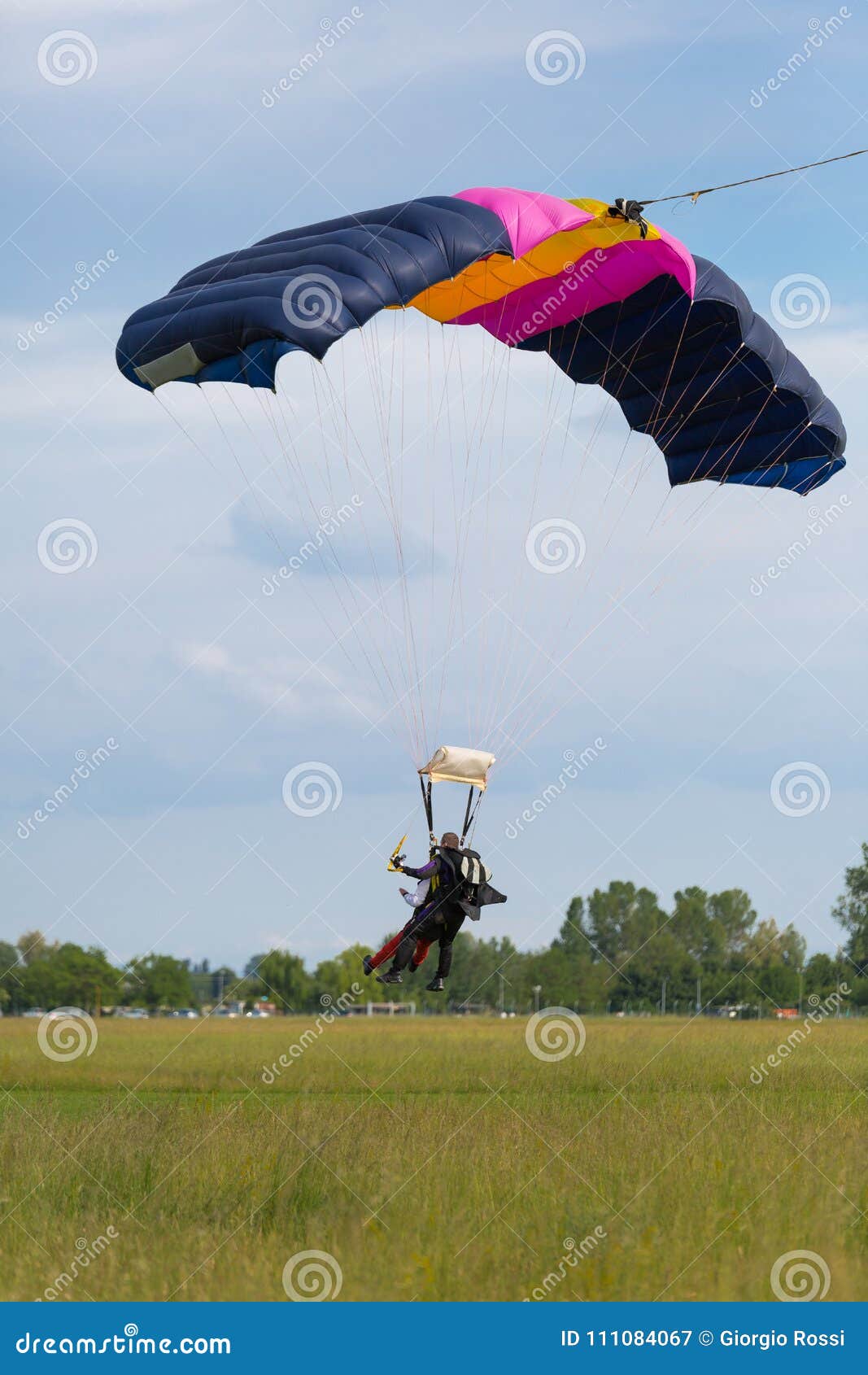 Parachutists: Instructor and Beginner with Blue Parachute Against Clear ...