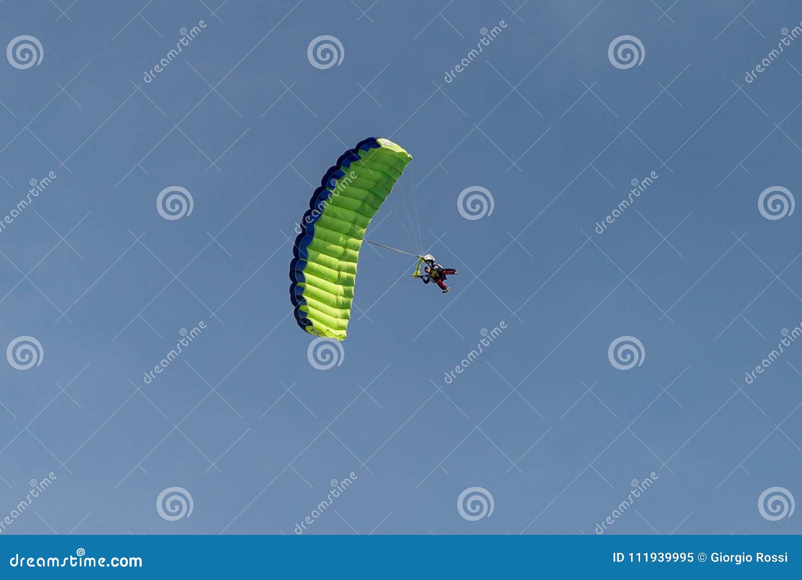 Parachutists: Instructor and Beginner with Green Parachute Against ...
