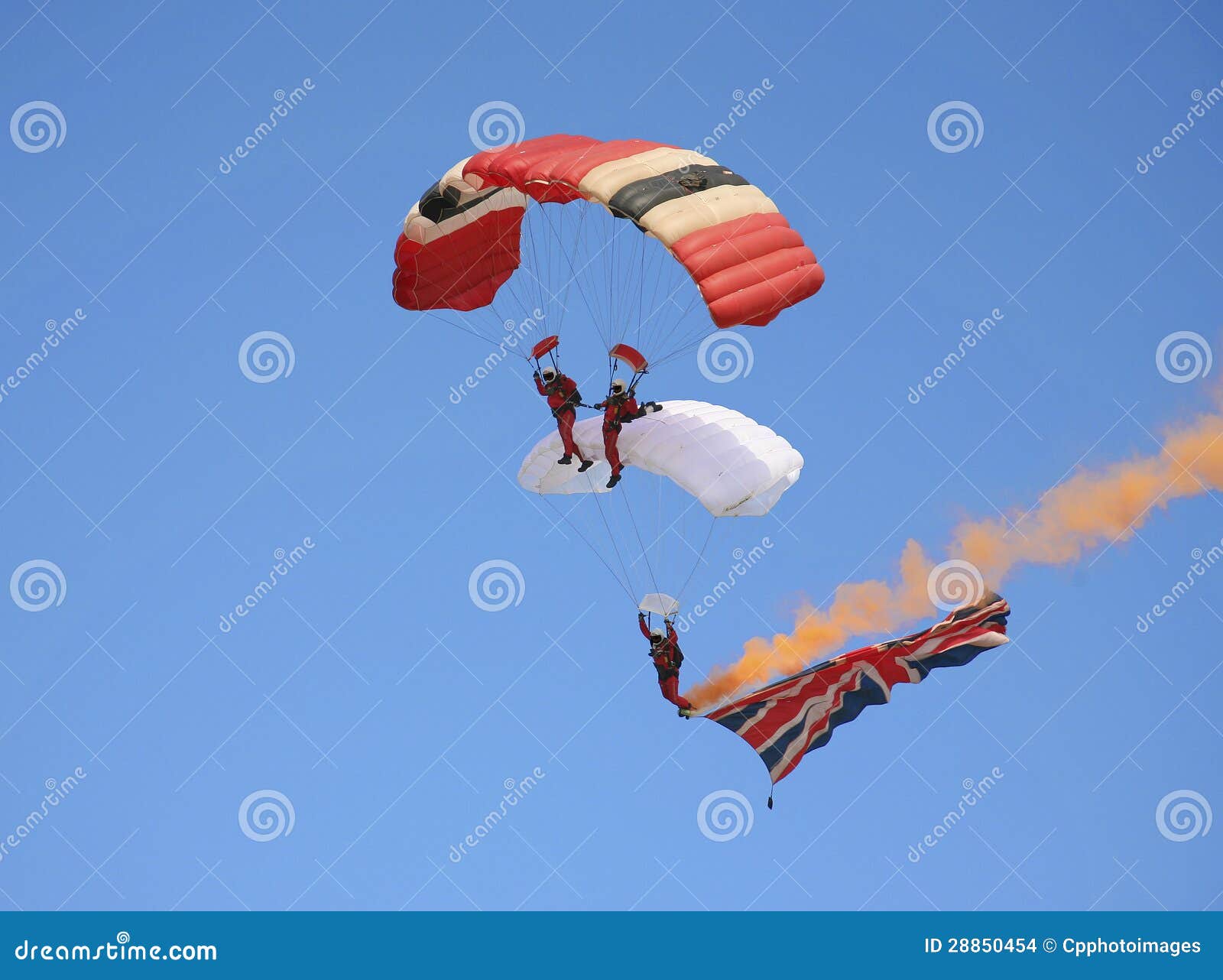 Parachutists Skydiving and Trailing a Flag Stock Photo - Image of ...