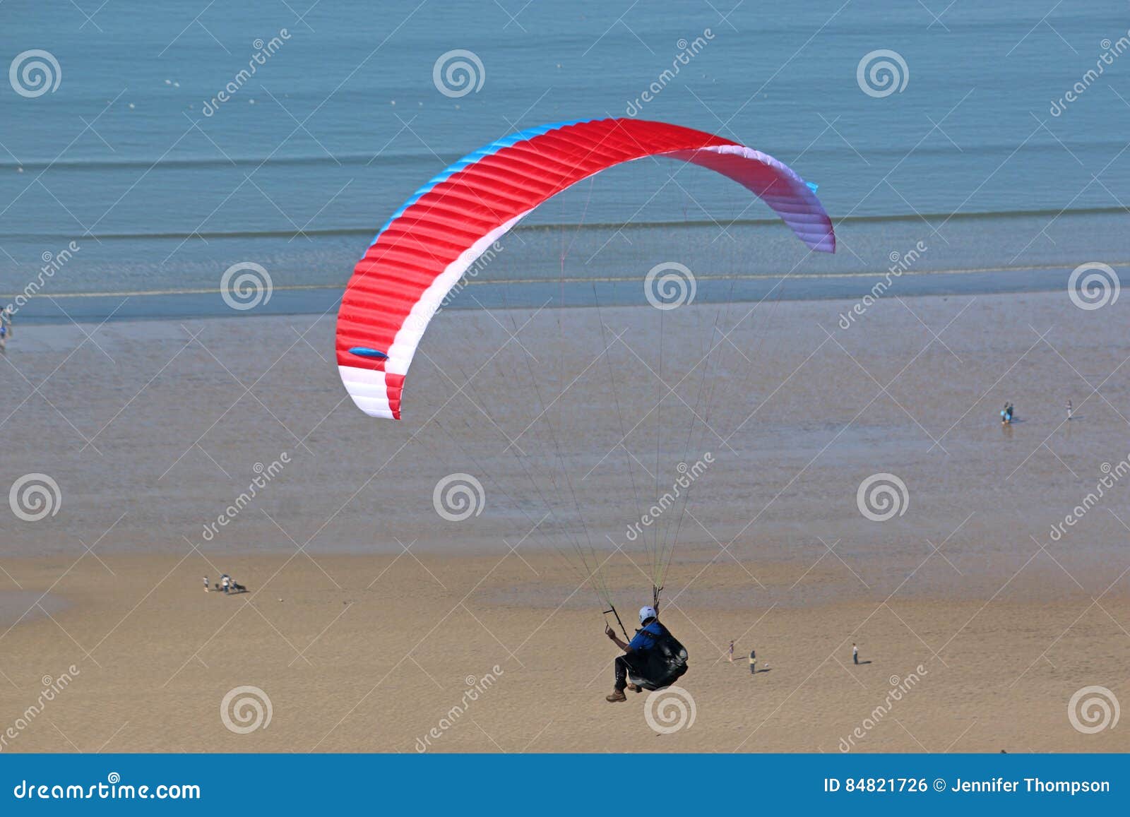 Paraglider above a beach stock photo. Image of flying - 84821726