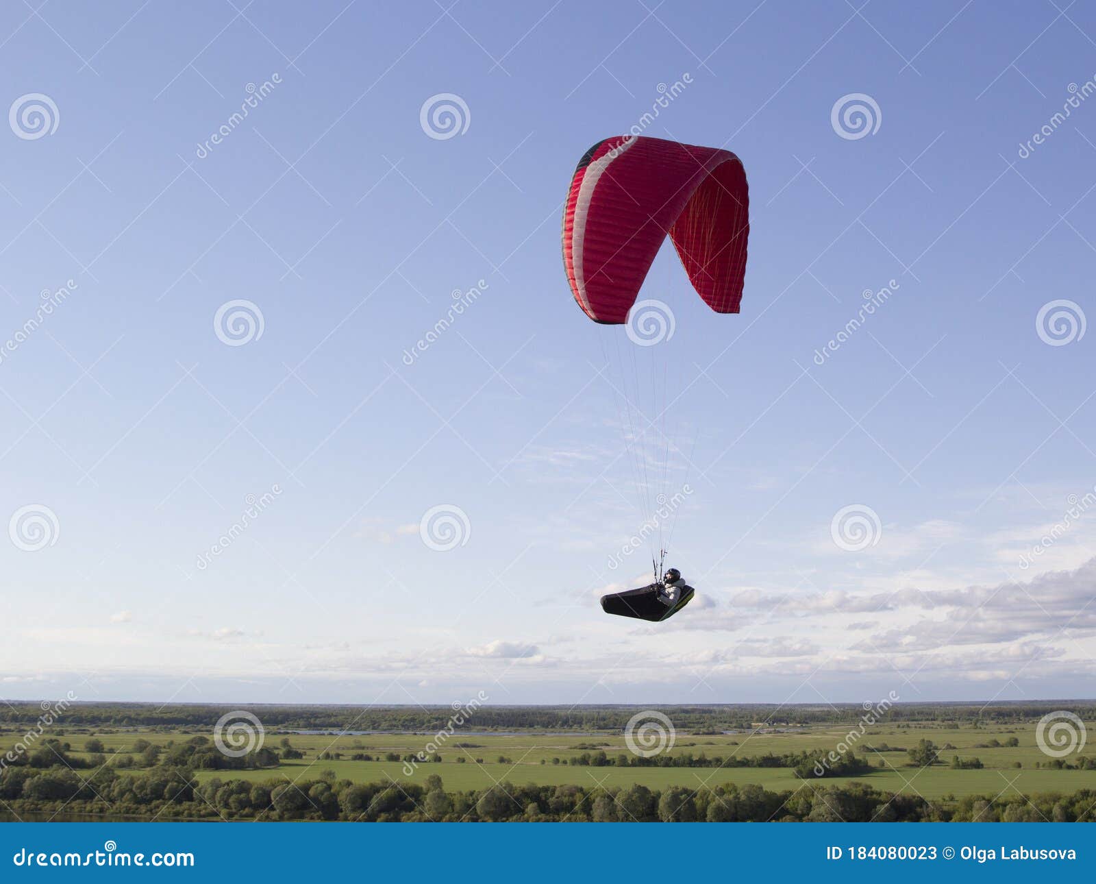 A Paraglider Athlete Flies a Red Paraglider Stock Image - Image of ...