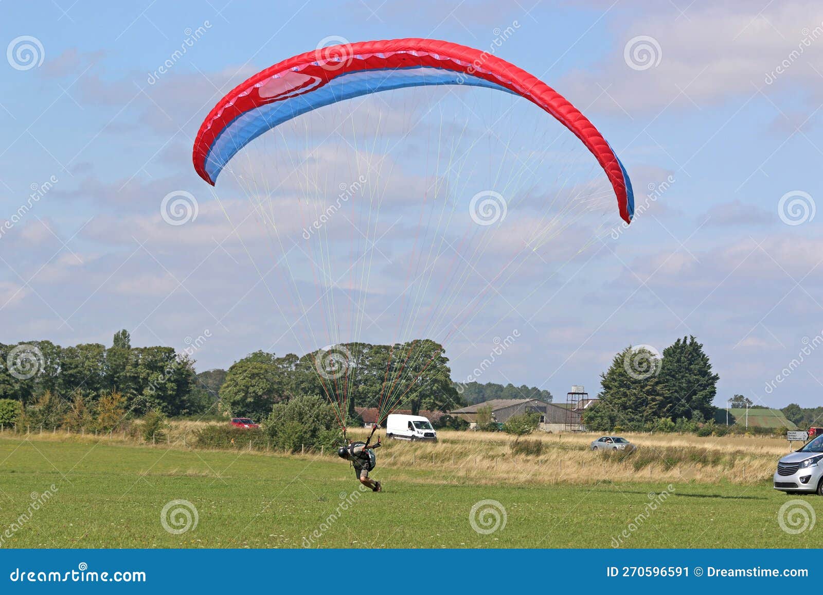 Paraglider Ground Handling His Wing in a Field Stock Image - Image of ...