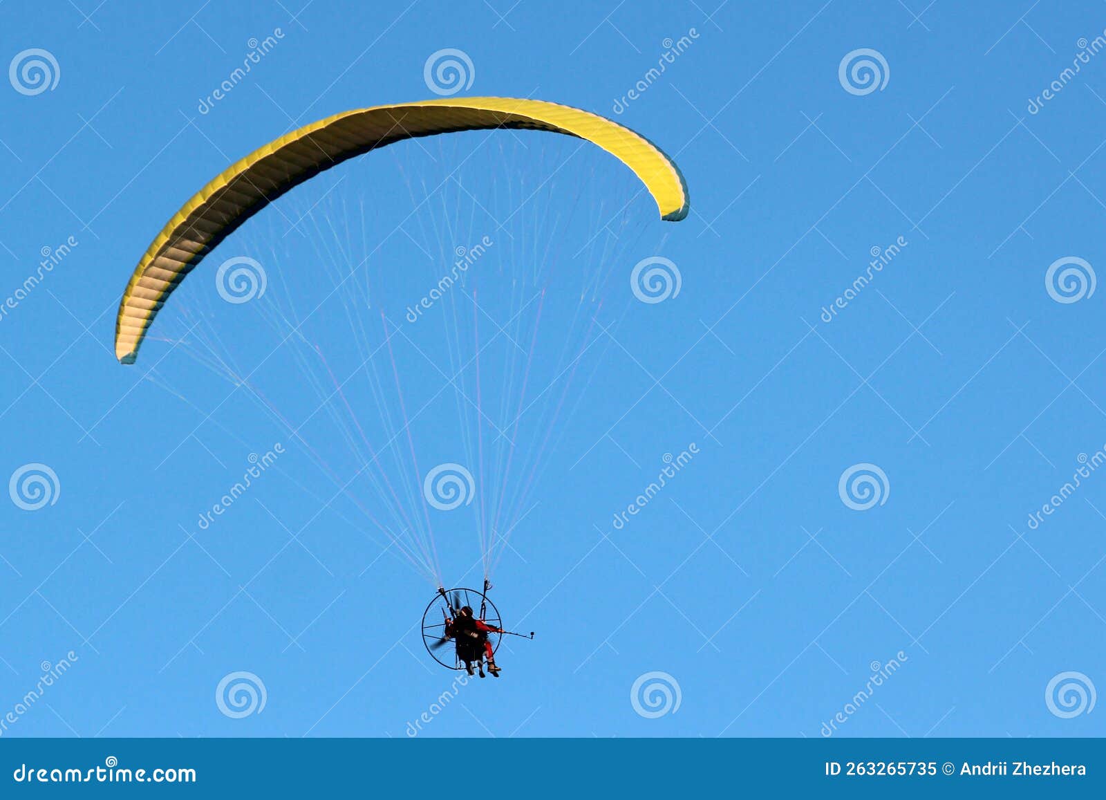 Paragliding in a Blue Sky, Pilot Controls Motorized Flying Machine ...