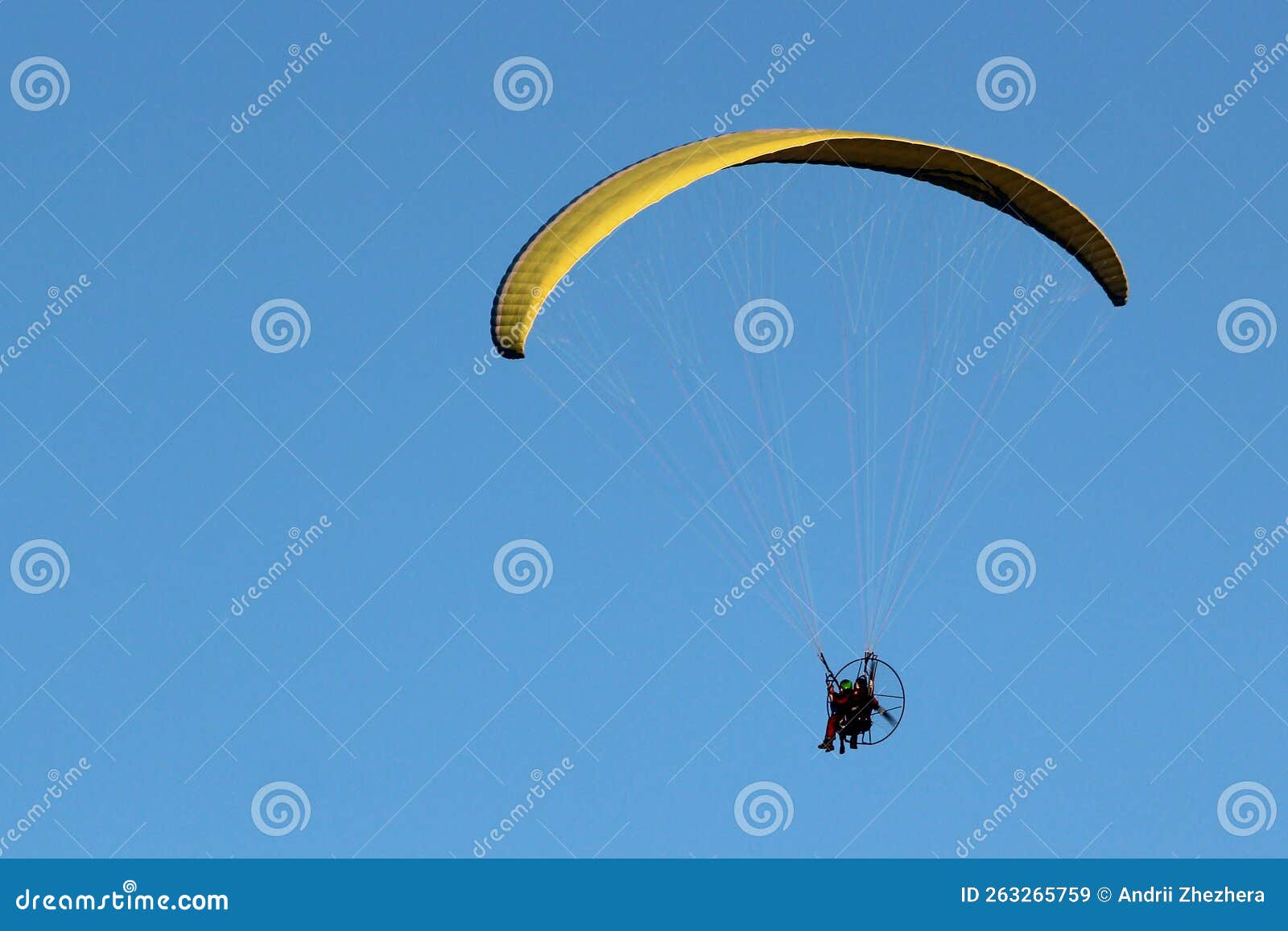 Paragliding in a Blue Sky, Pilot Controls Motorized Flying Machine ...